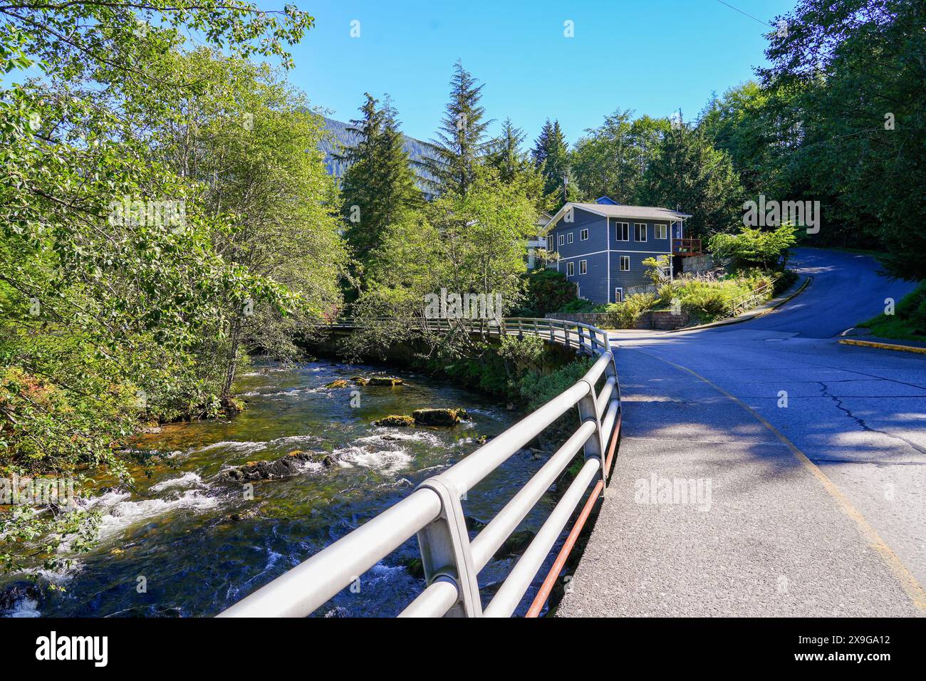 Road curving around the bed of the Ketchikan Creek in southeast Alaska ...