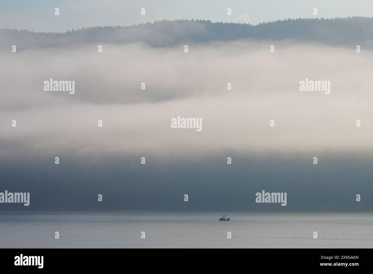 Fishing boat in the Inside Passage of Southeastern Alaska, navigating ...