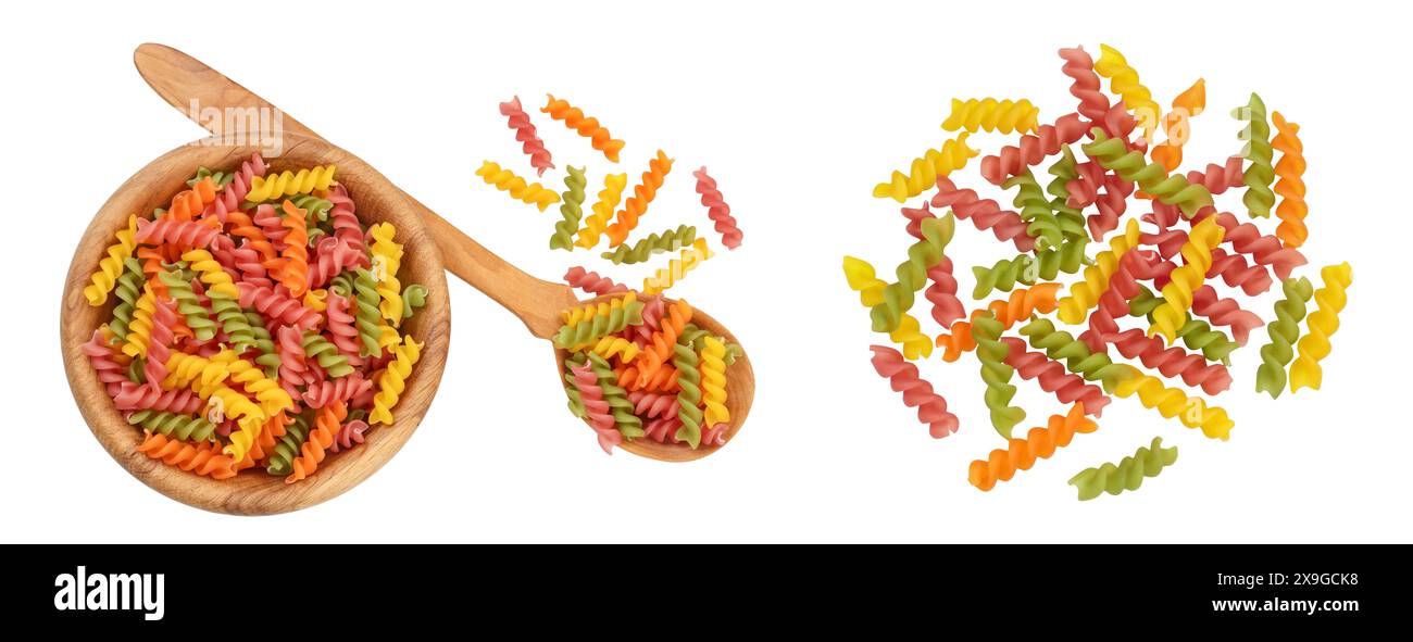 raw Fusilli colored pasta in wooden bowl isolated on white background ...