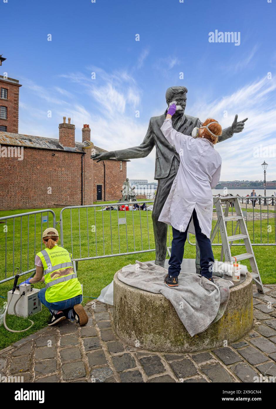Lady conservationists cleaning the Billy Fury statue on the waterfront ...