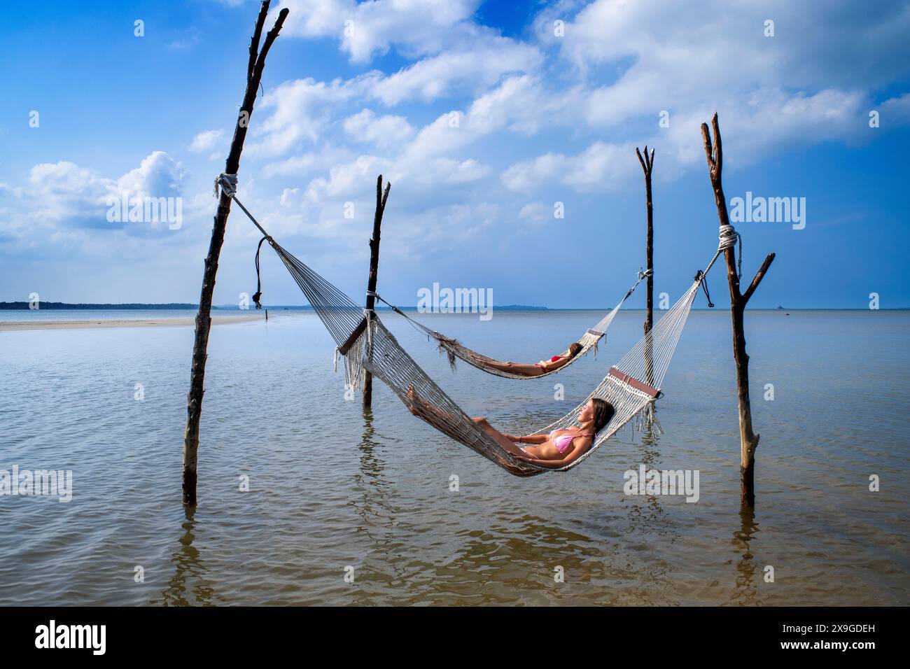 Twilight with couple in sea swing in the The residence luxury resort ...