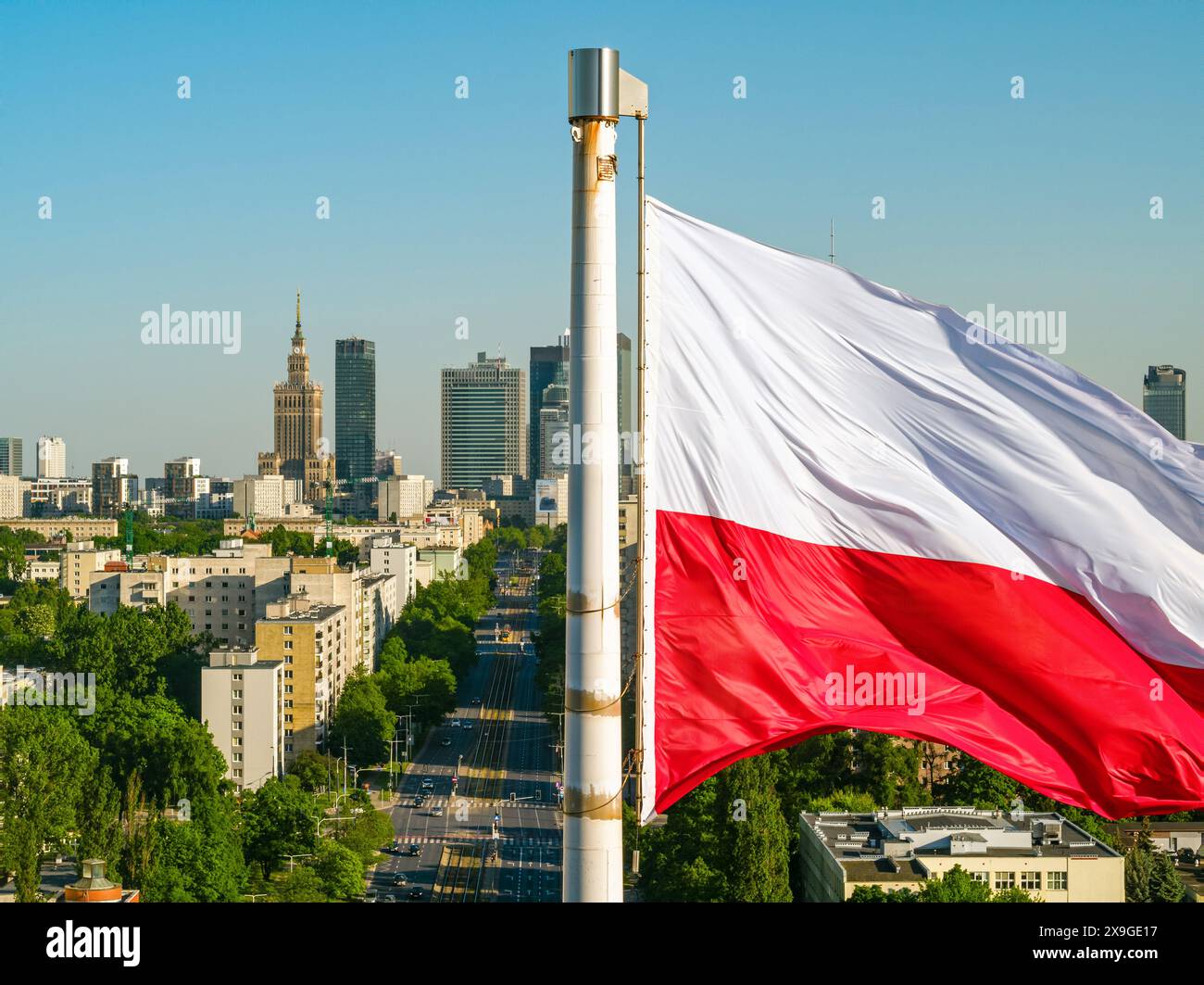 Polish national white and red flag against skyscrapers in Warsaw city ...