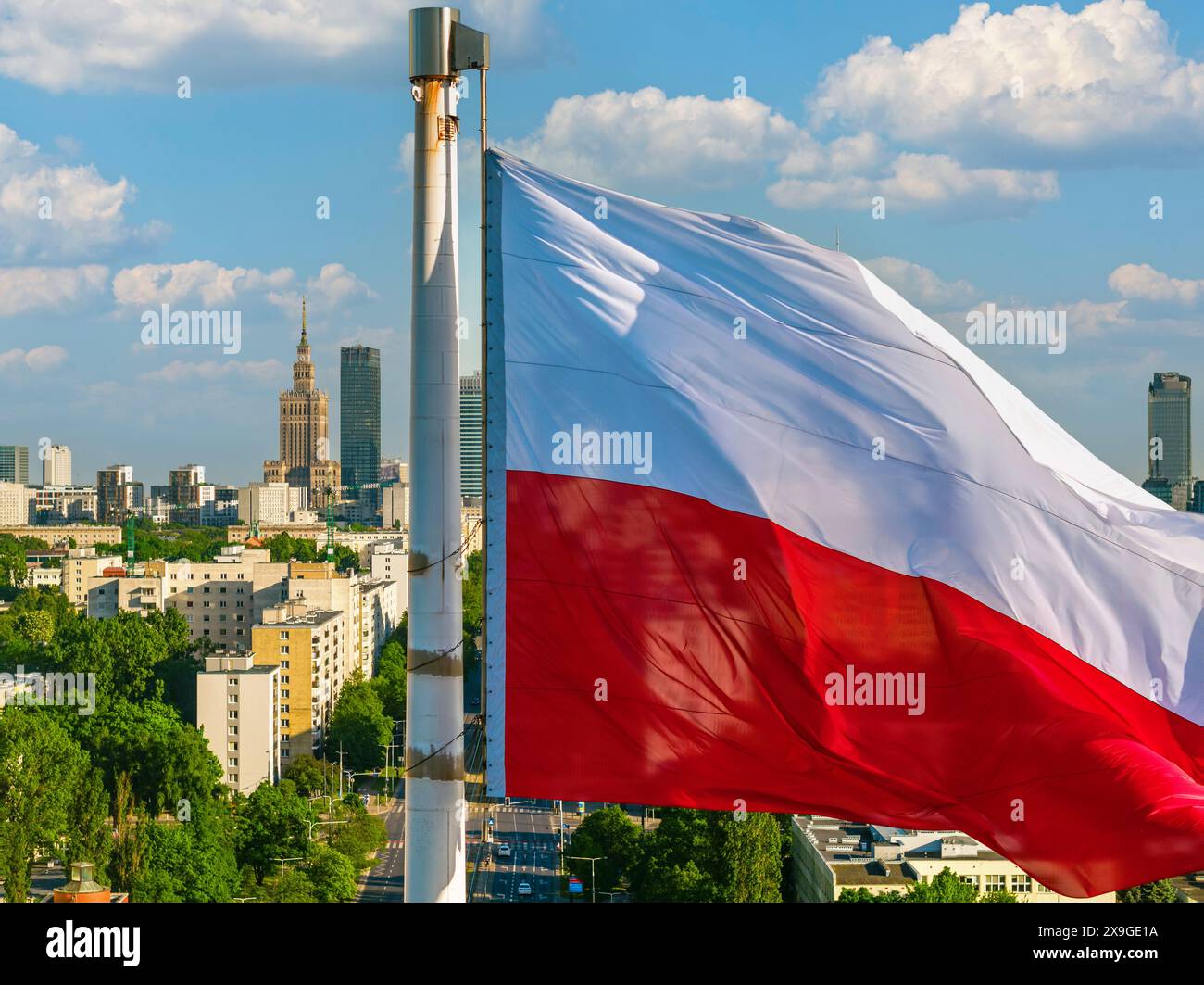 Polish national white and red flag against skyscrapers in Warsaw city ...