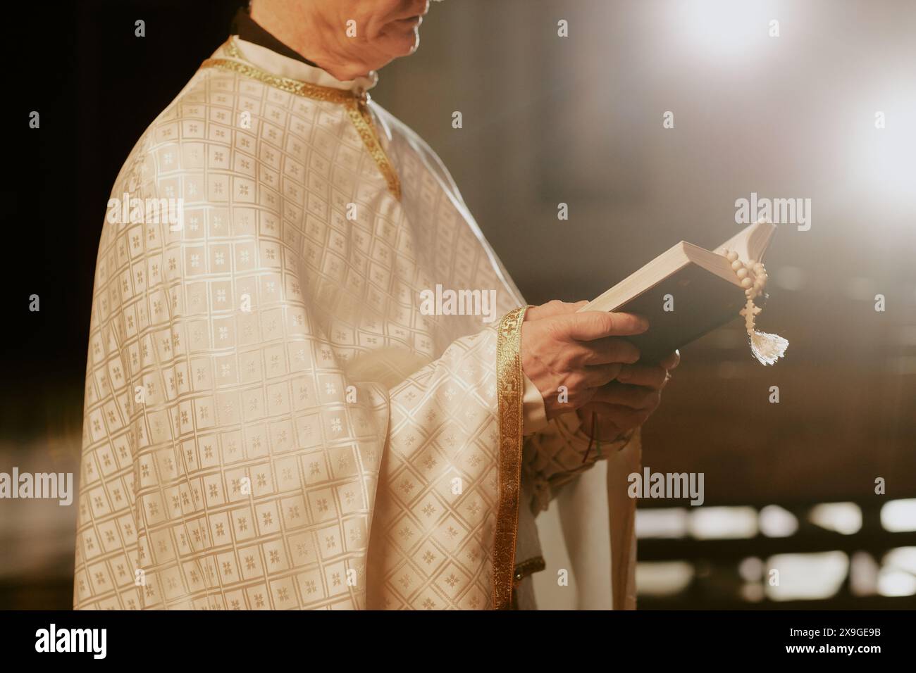 Crop shot of unrecognizable senior Catholic priest wearing liturgical ...