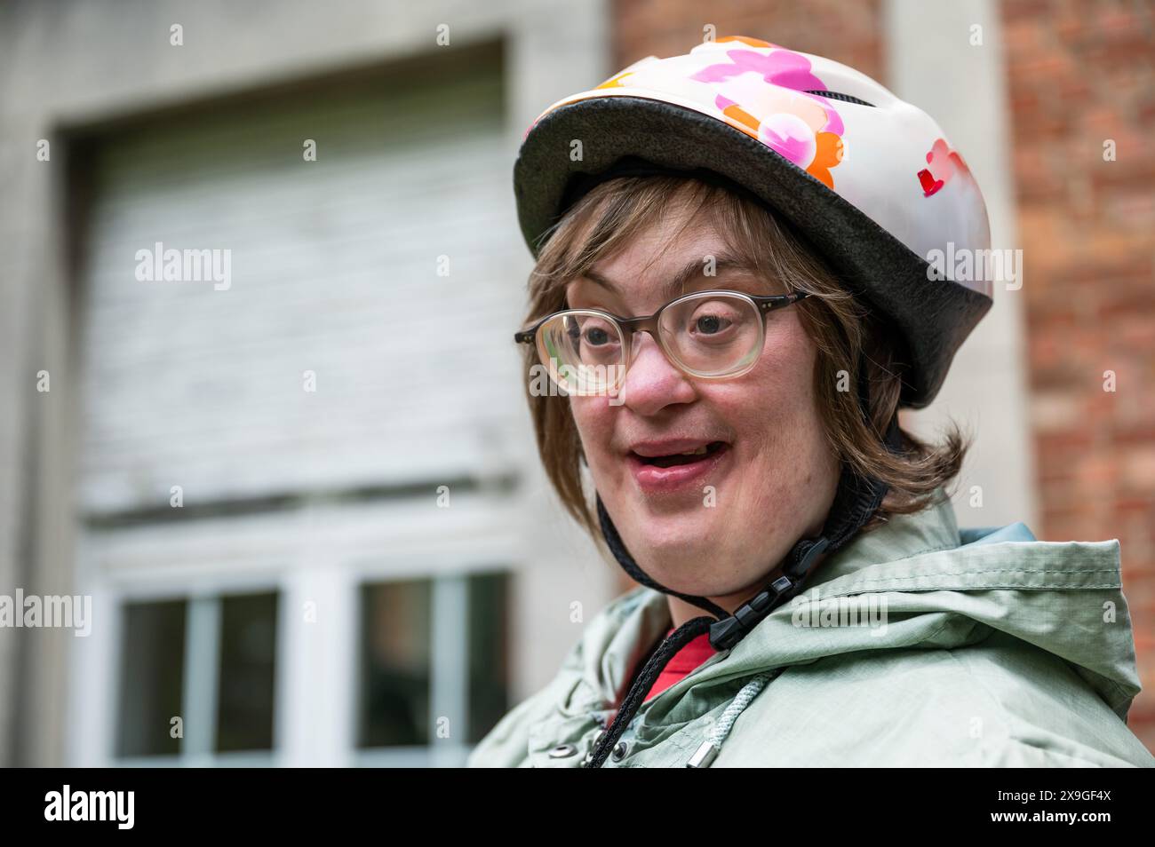Outdoor portrait of a 41 yo woman with the Down Syndrome wearing a ...