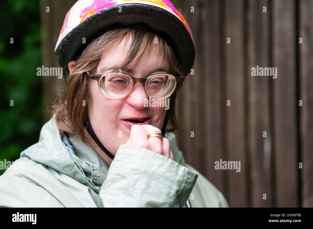 Outdoor portrait of a 41 yo woman with the Down Syndrome wearing a ...