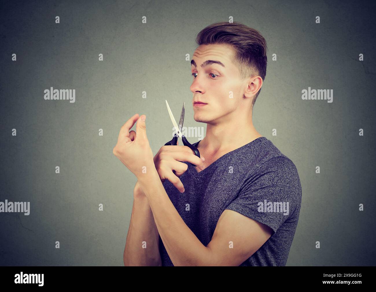Liar young man about to cut with scissors his imaginary long nose Stock ...
