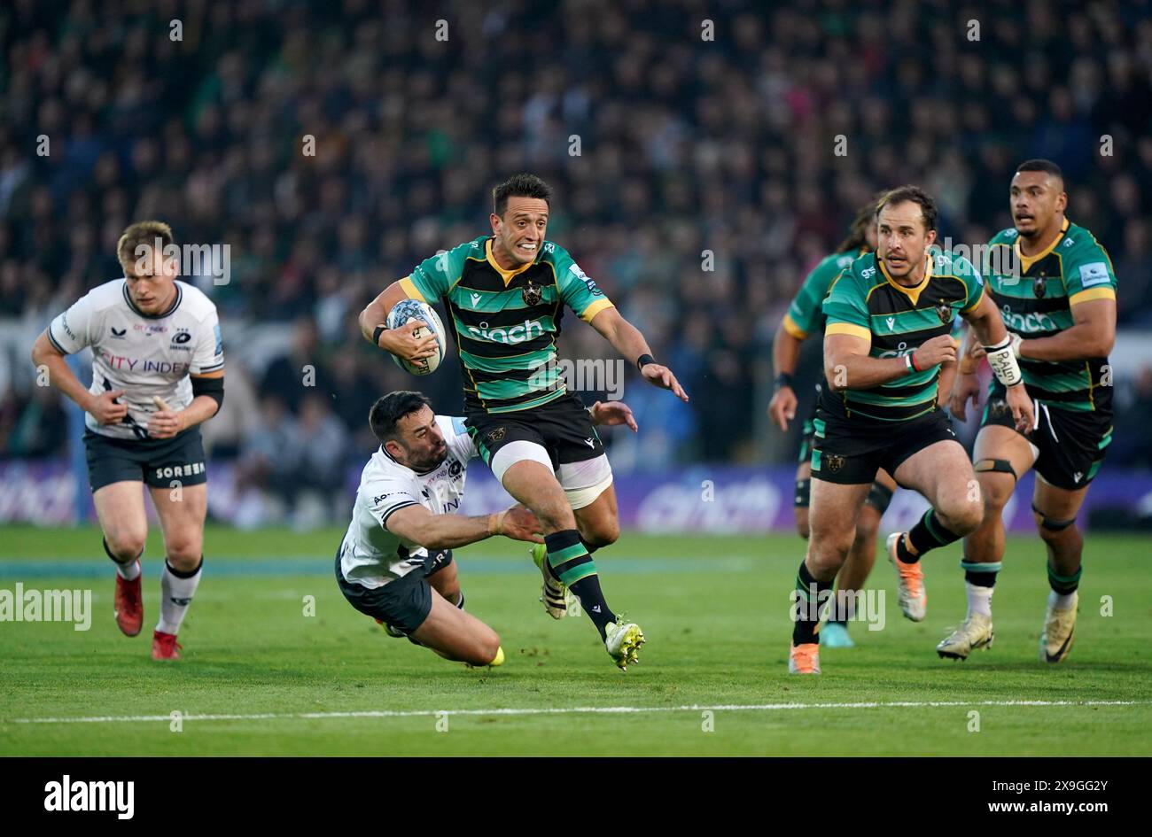 Northampton Saints' Alexander Mitchell is tackled by Saracens' Alex ...