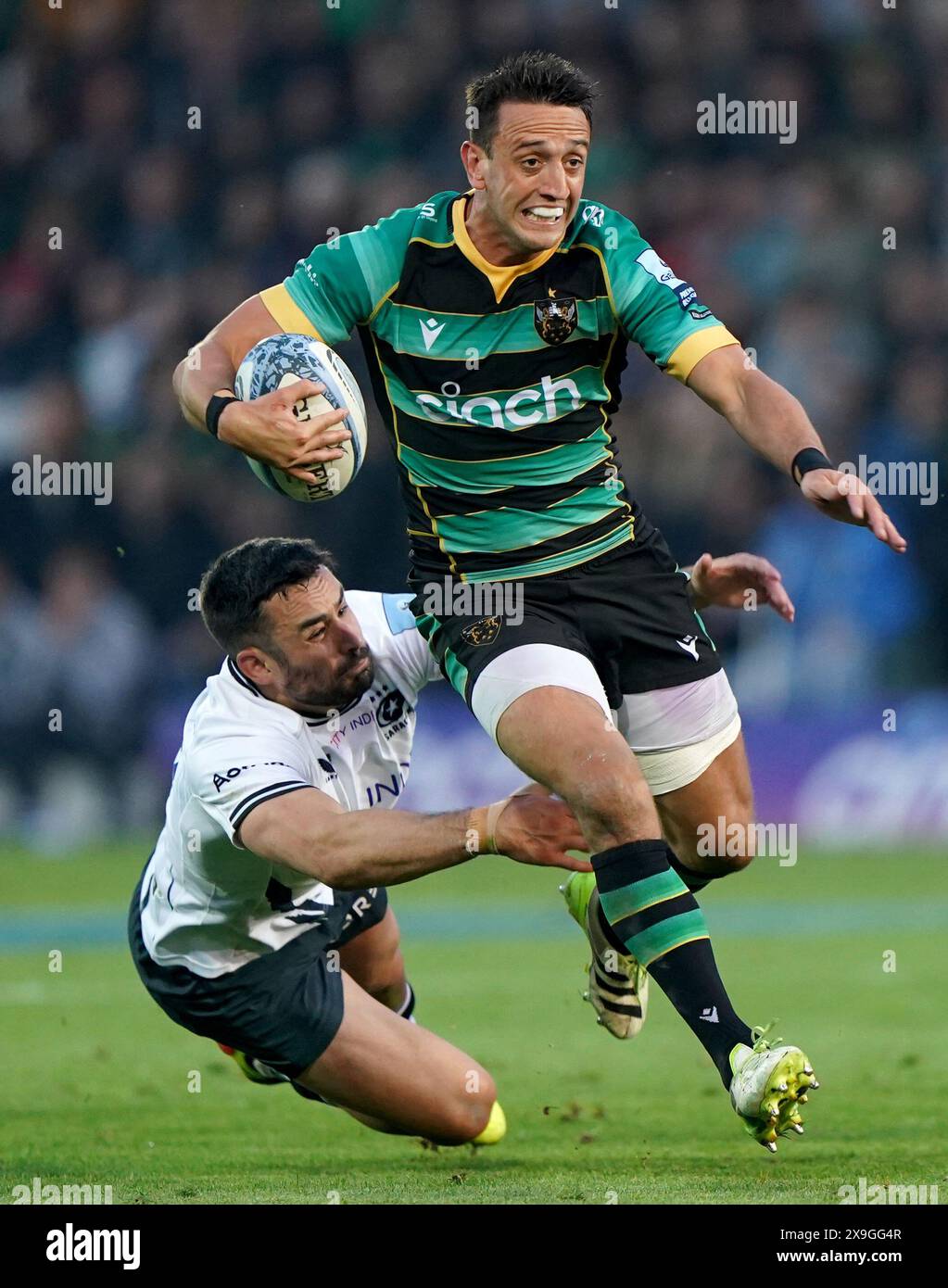 Northampton Saints' Alexander Mitchell is tackled by Saracens' Alex ...