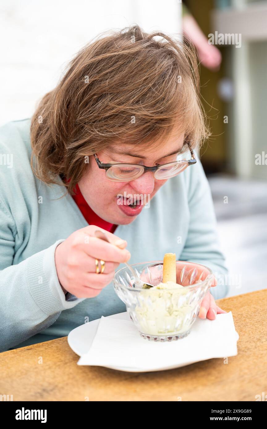 41 yo white woman with the Down Syndrome eating ice cream, Tienen ...