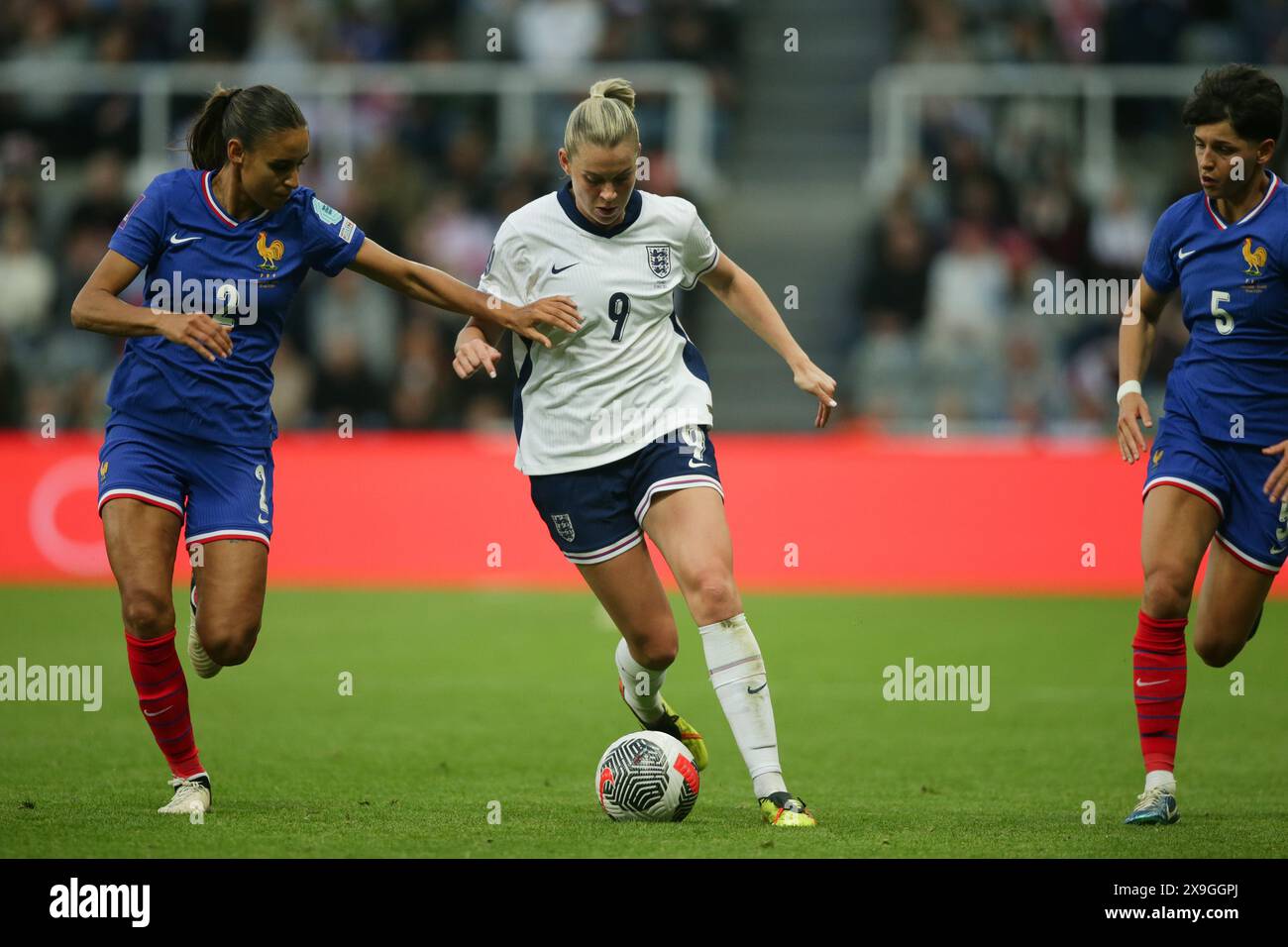 England's Alessia Russo and France's Maelle Lakrar battle for the ball ...