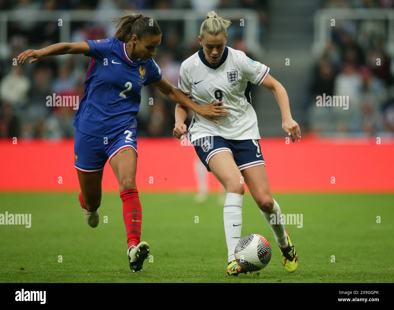 England's Alessia Russo and France's Maelle Lakrar battle for the ball ...
