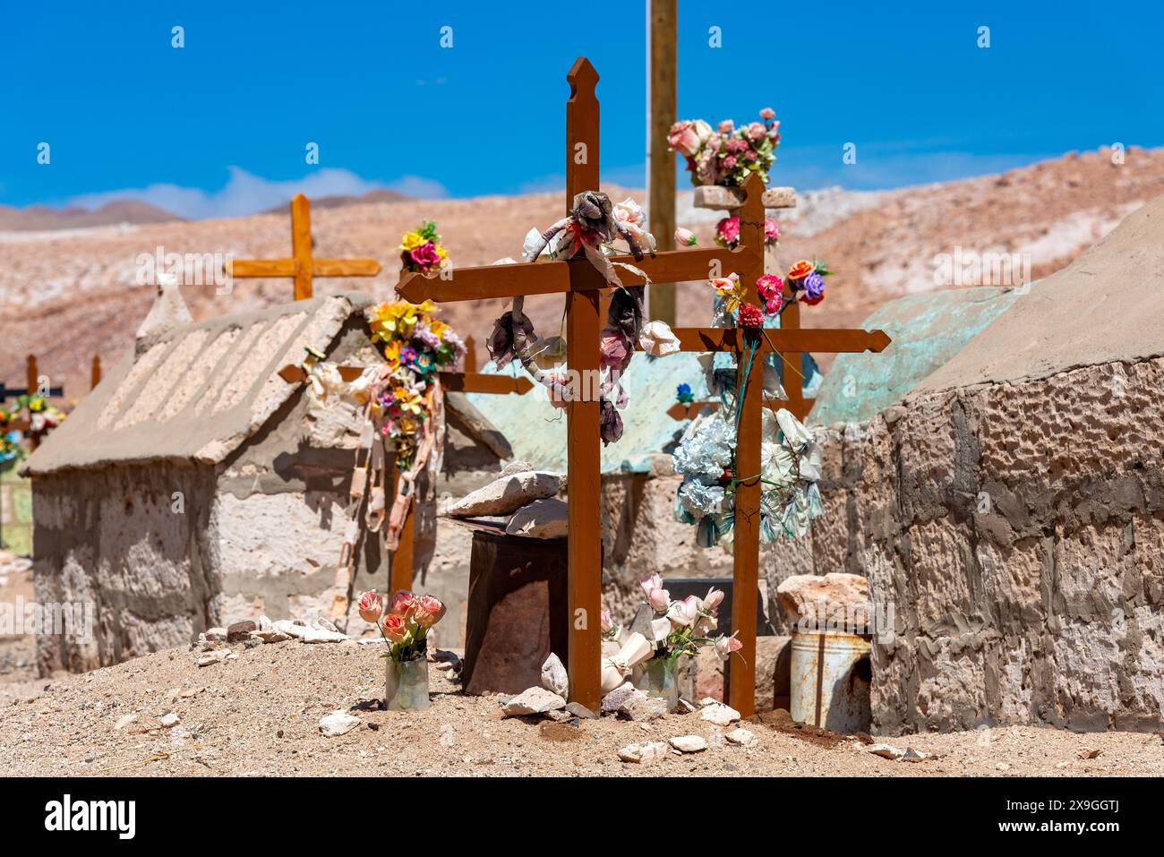 In the Atacama Desert of Chile, colorful crosses and flowers adorn an ...