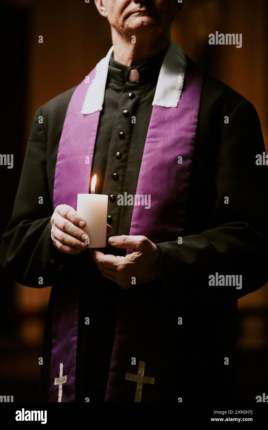 Vertical crop shot of senior Catholic priest wearing soutane and stole ...