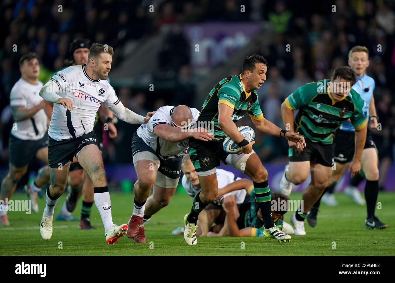 Northampton Saints' Alexander Mitchell is tackled by Saracens' Ollie ...