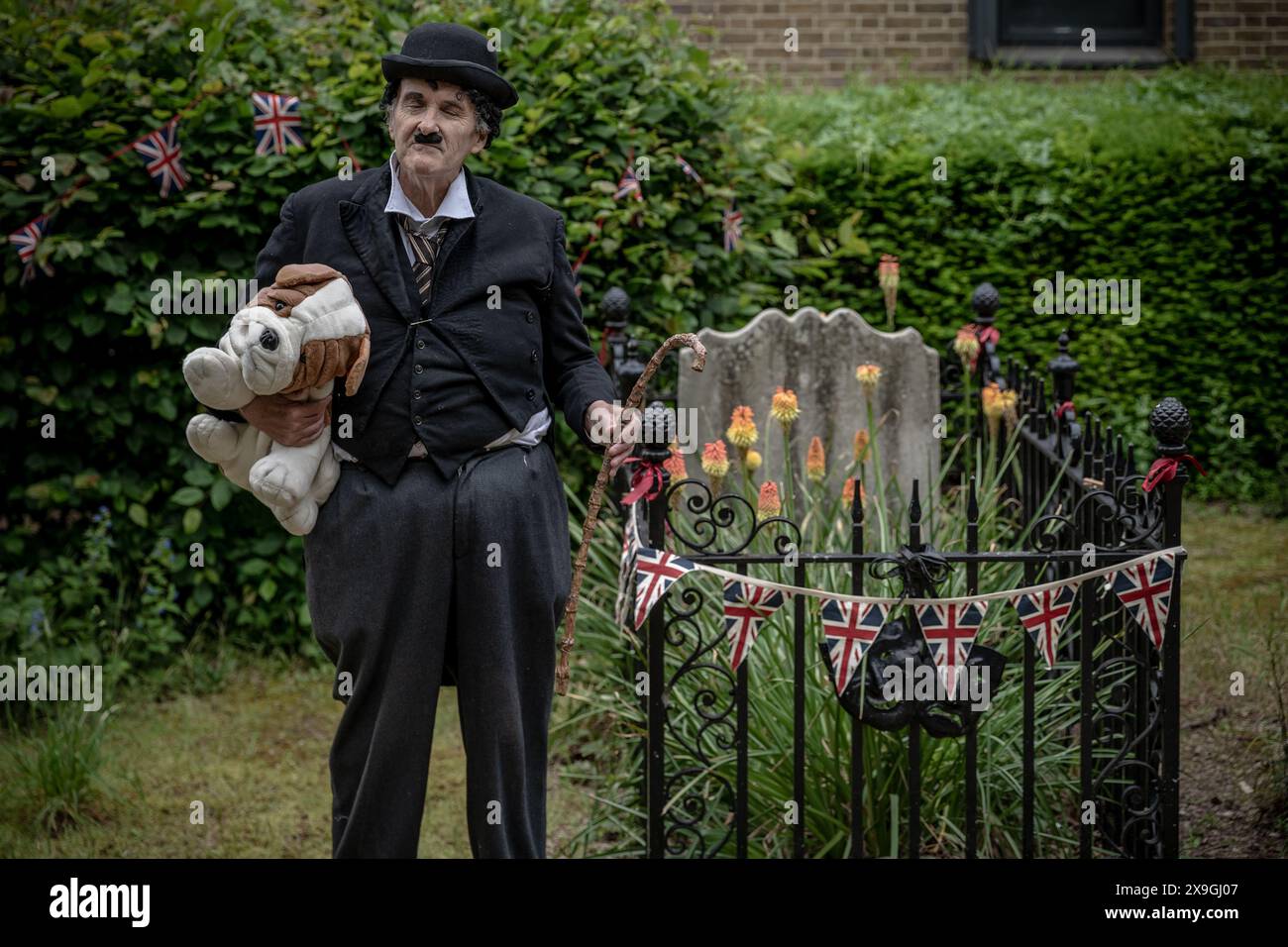 London, UK. 31st May 2024. David Girt as Charlie Chaplin arrives to pay ...