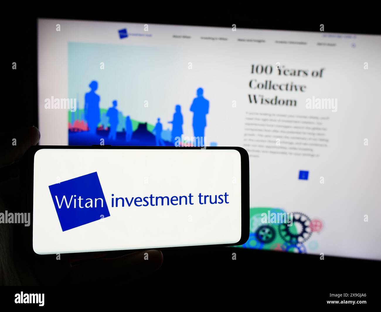 Person holding smartphone with logo of British company Witan Investment ...