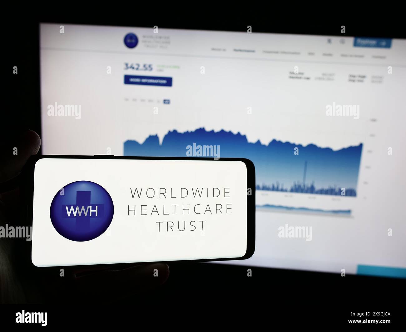 Person holding mobile phone with logo of British company Worldwide ...