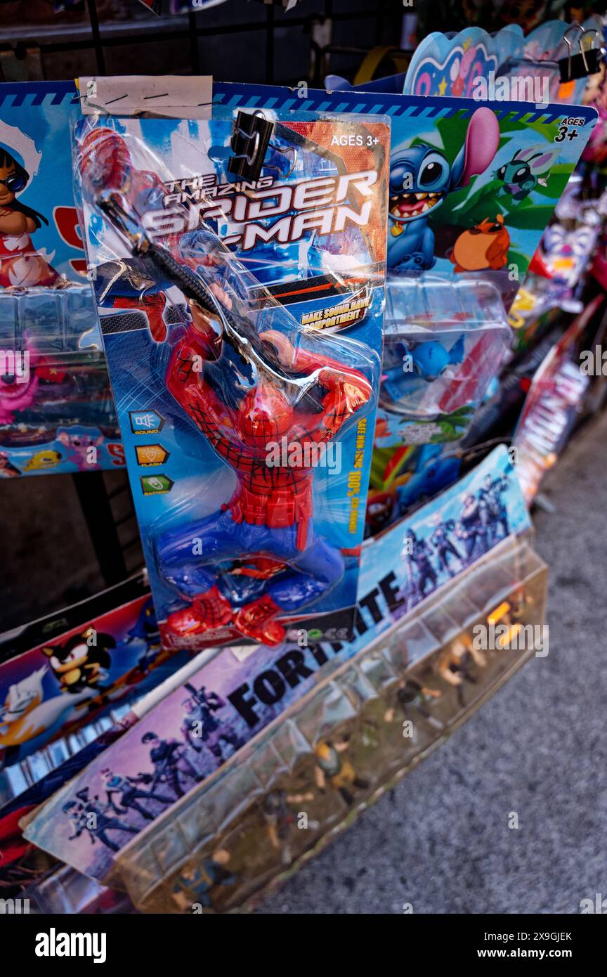 Bootleg toy stand featuring a spider-man figure holding a rifle in a ...