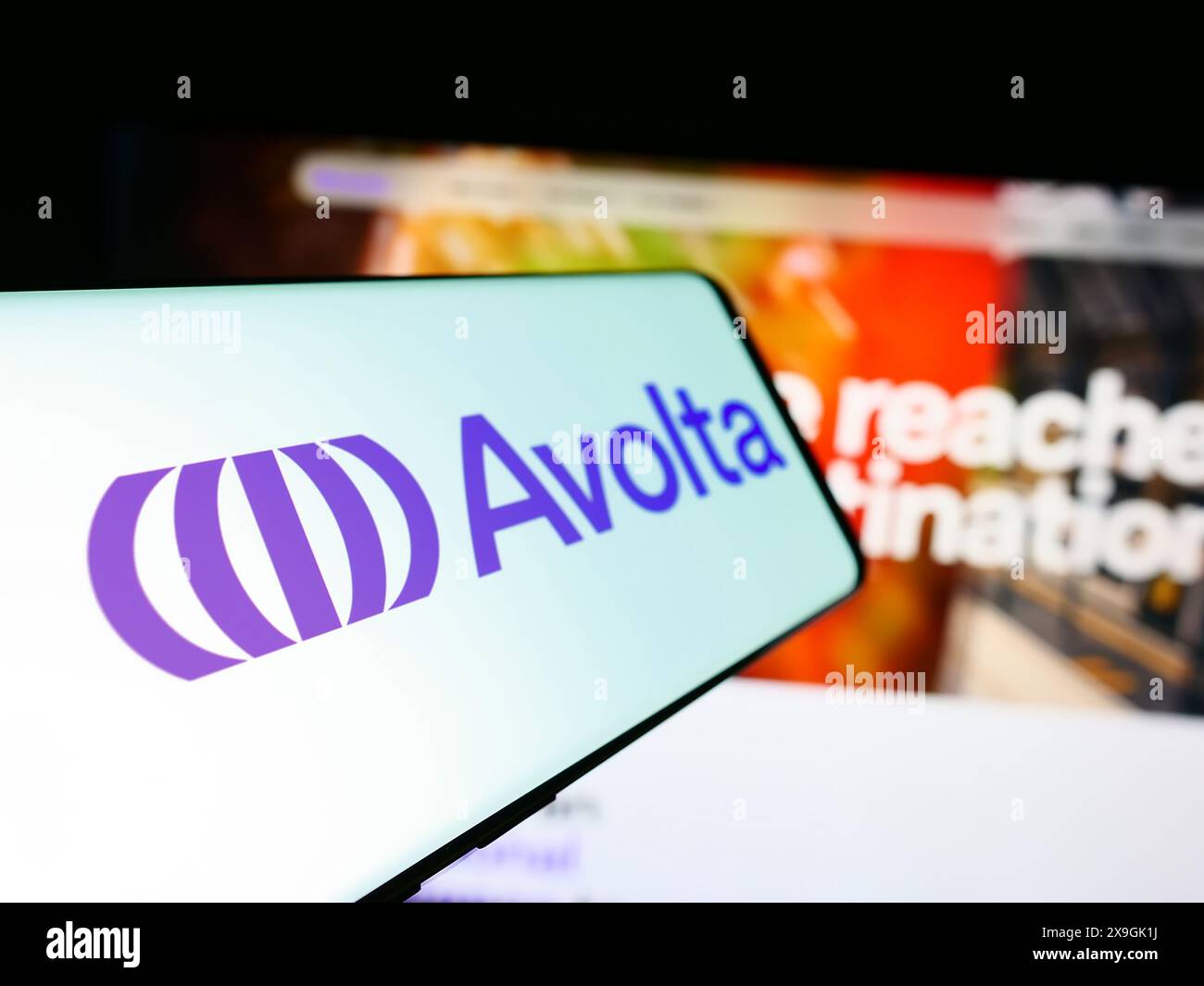 Smartphone with logo of Swiss travel retail company Avolta AG in front ...