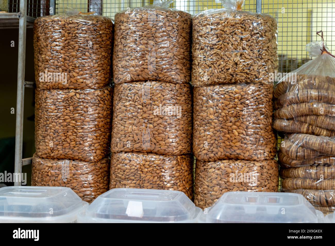 bustling market shop, examining bins of freshly harvested almonds. The ...