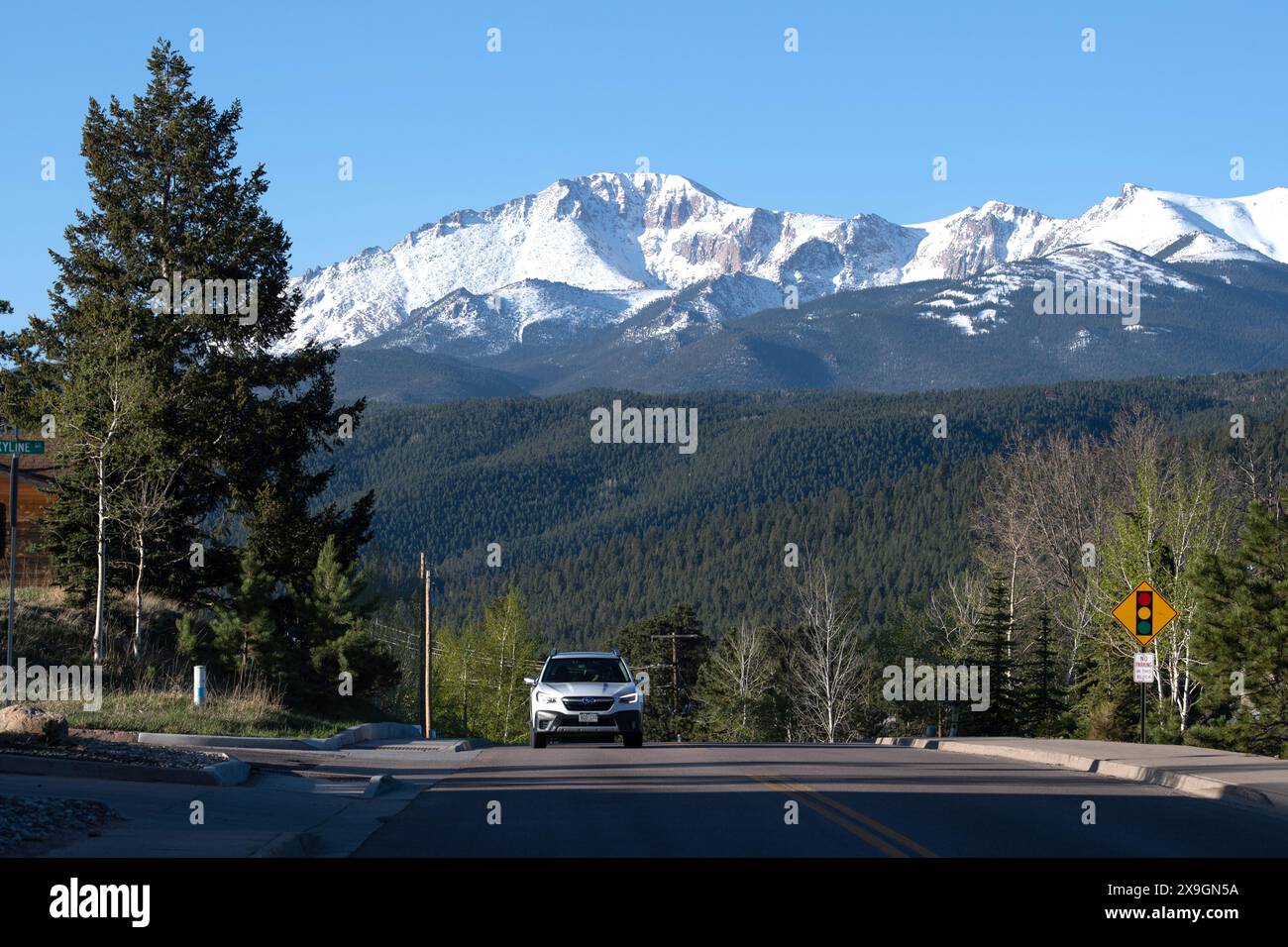 Cars drive through Woodland Park, Colorado, a small mountain community ...
