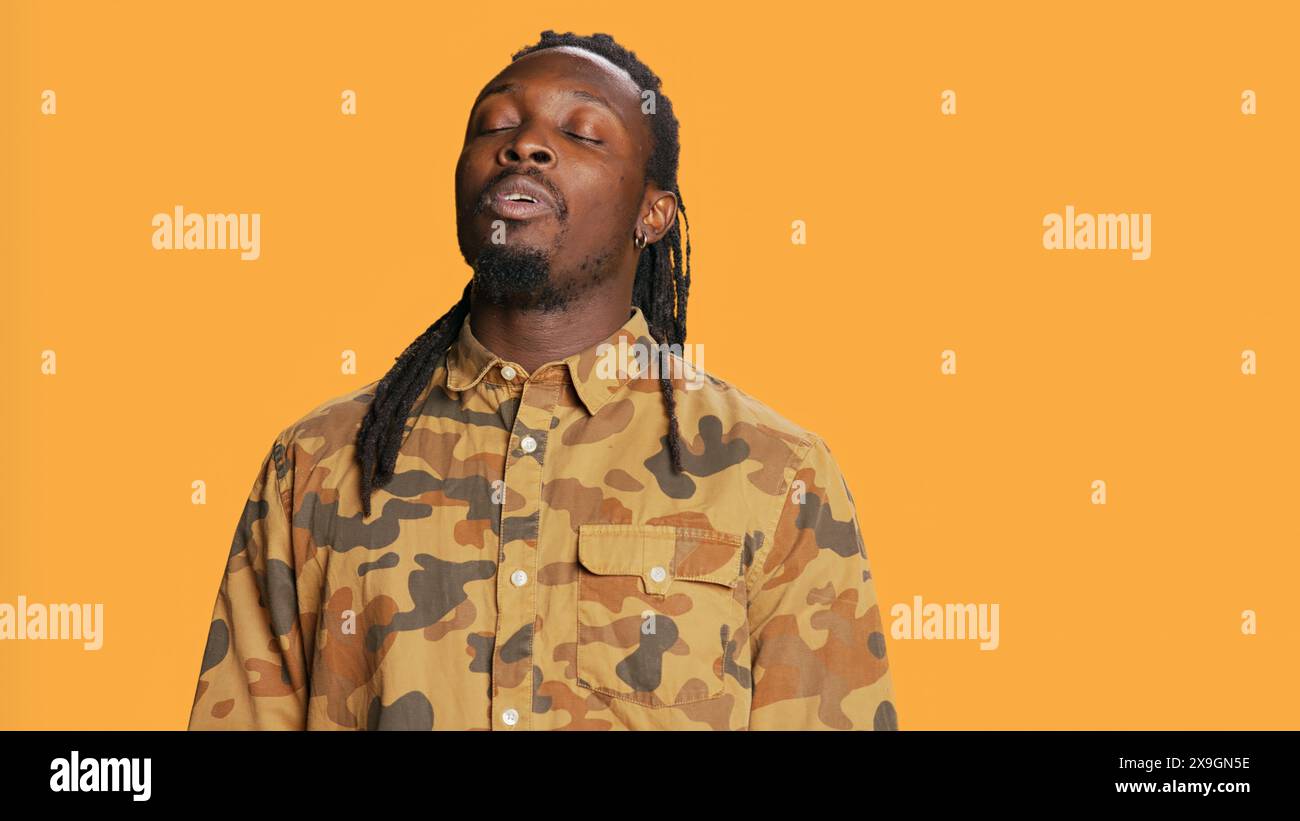 Male model inhaling and exhaling in studio, showing breathing exercises ...