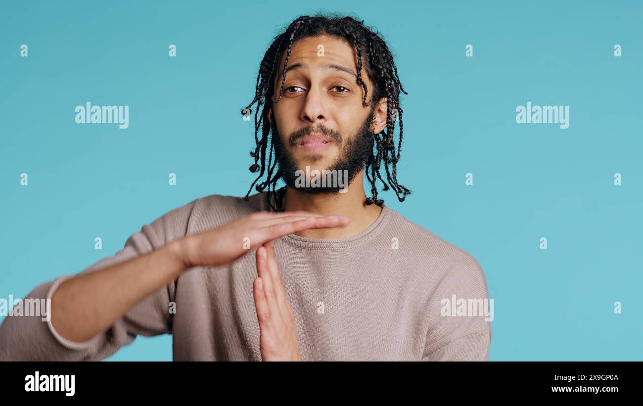 Assertive Middle Eastern man asking for timeout, doing hand gestures ...