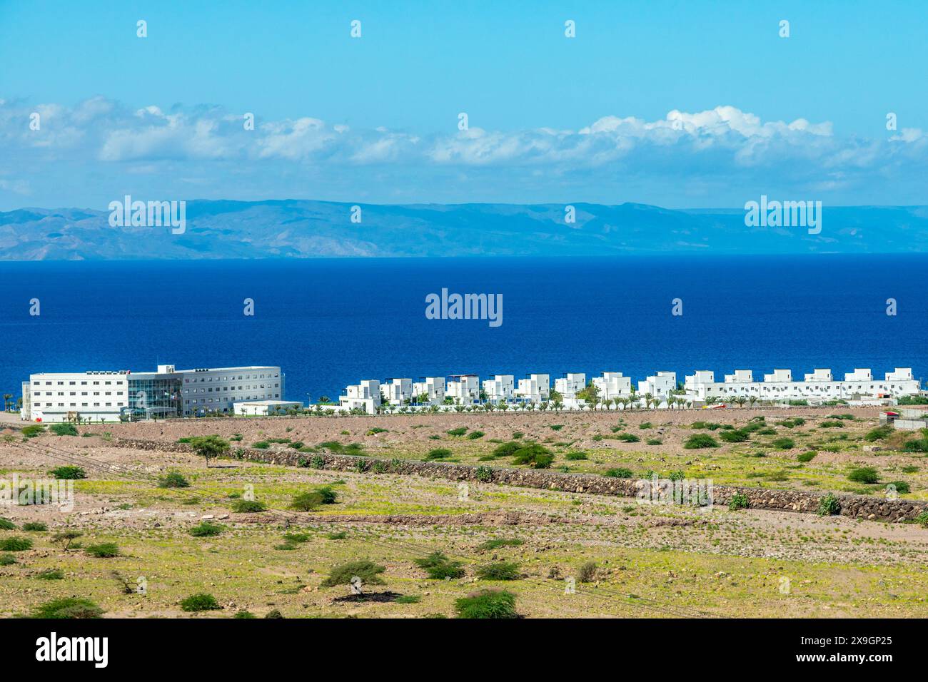 Tajoura city modern buildings and villas with gulf and mountains in the ...