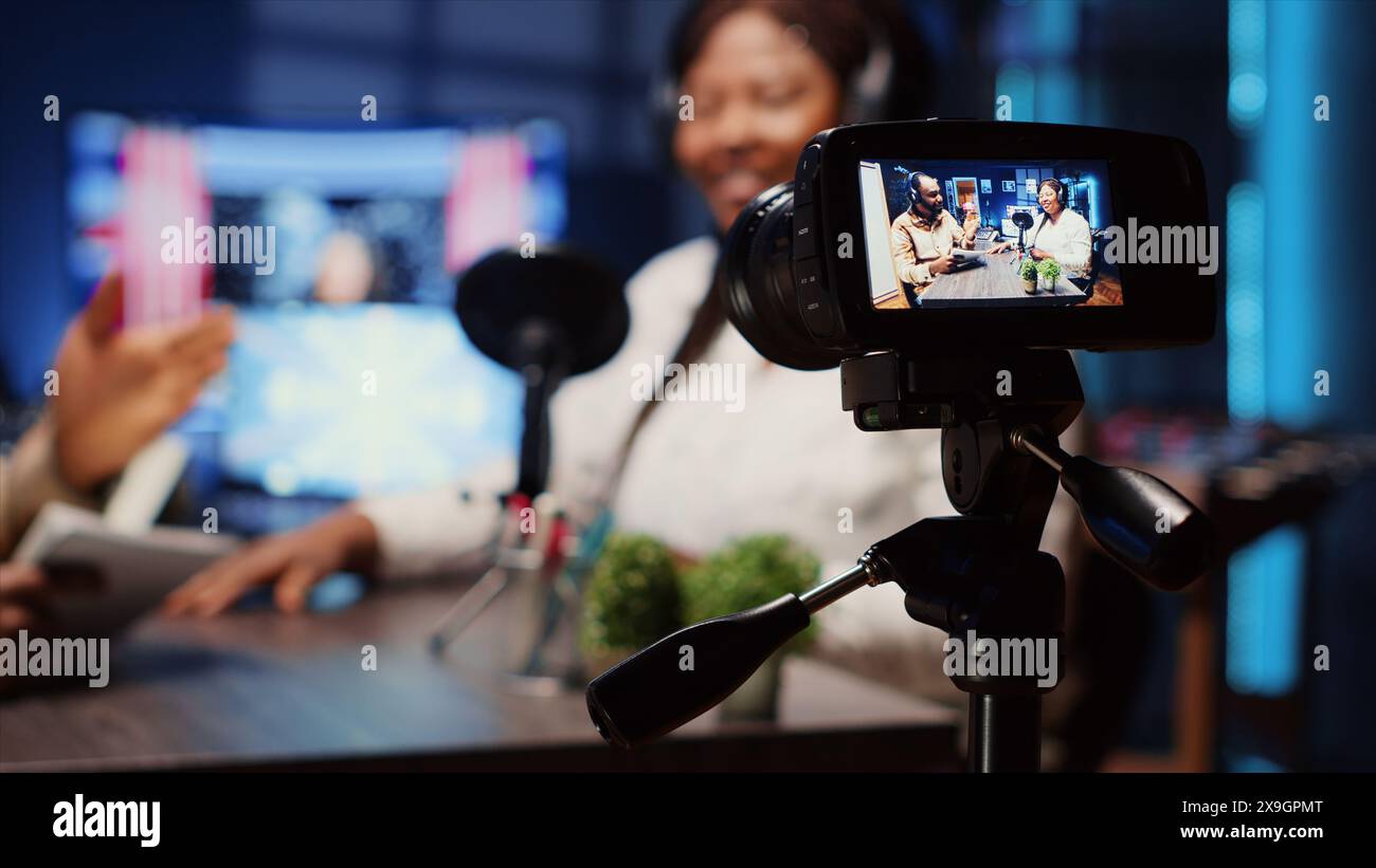 Focus on professional camera recording man in blurry background using ...