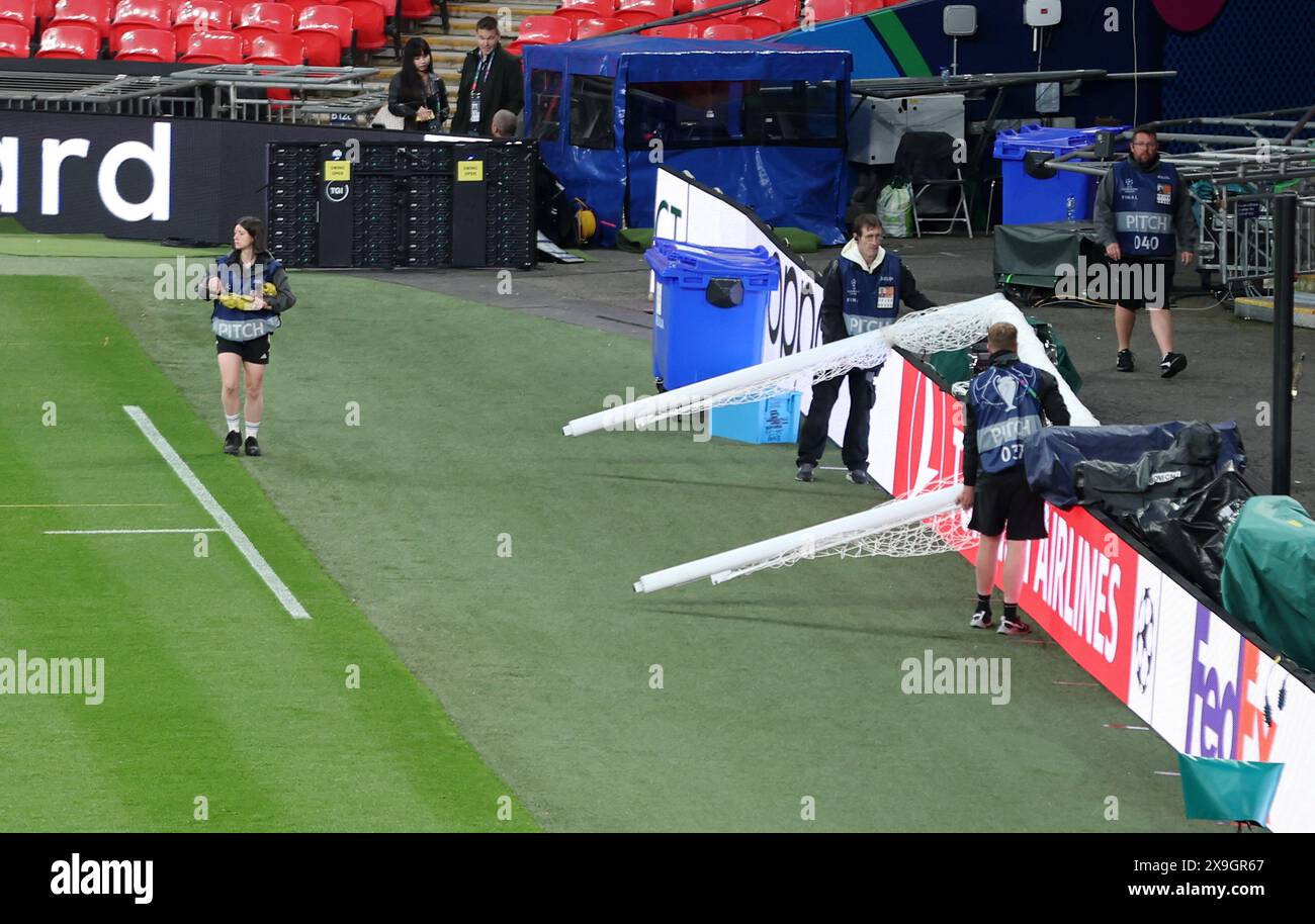 London, UK. 31st May, 2024. Workers carry goal post at Wembley Stadium ...