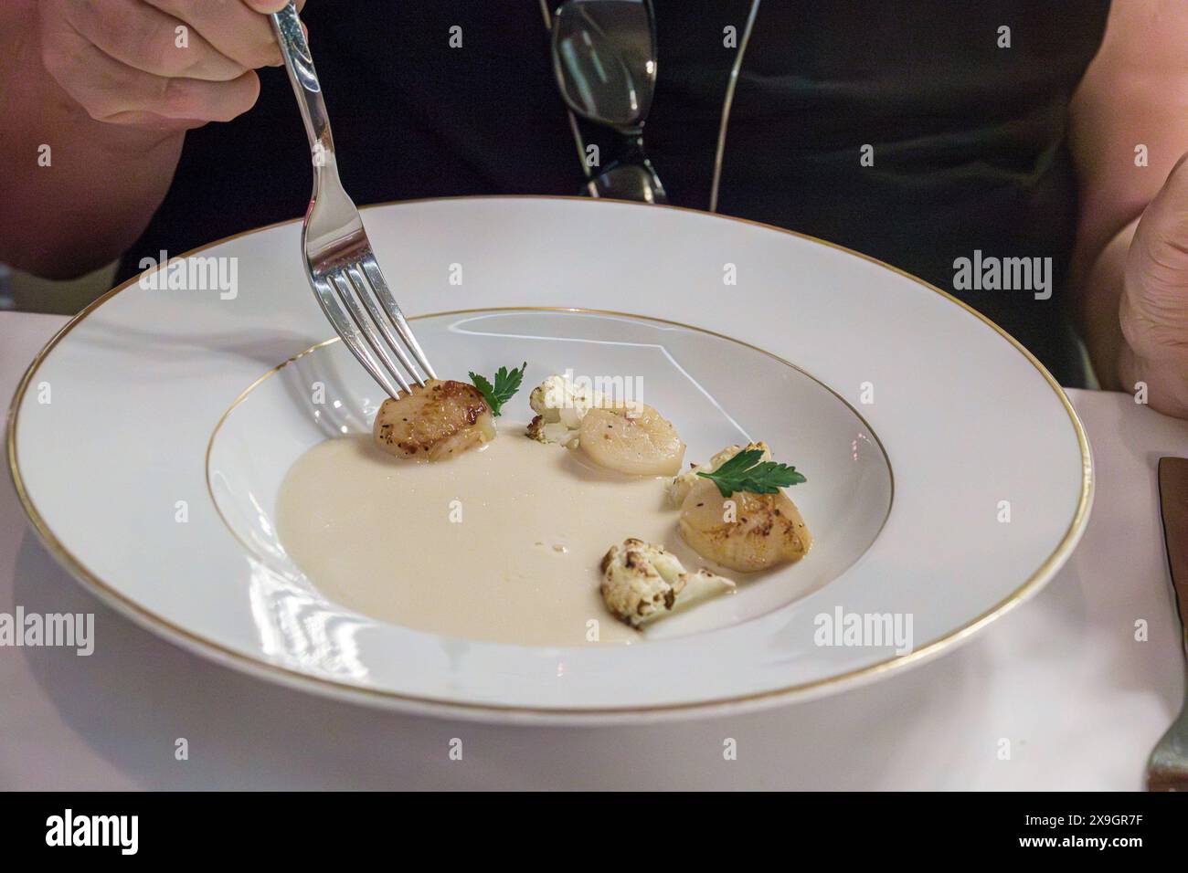 Woman eating seared scallops appetizer hi-res stock photography and ...