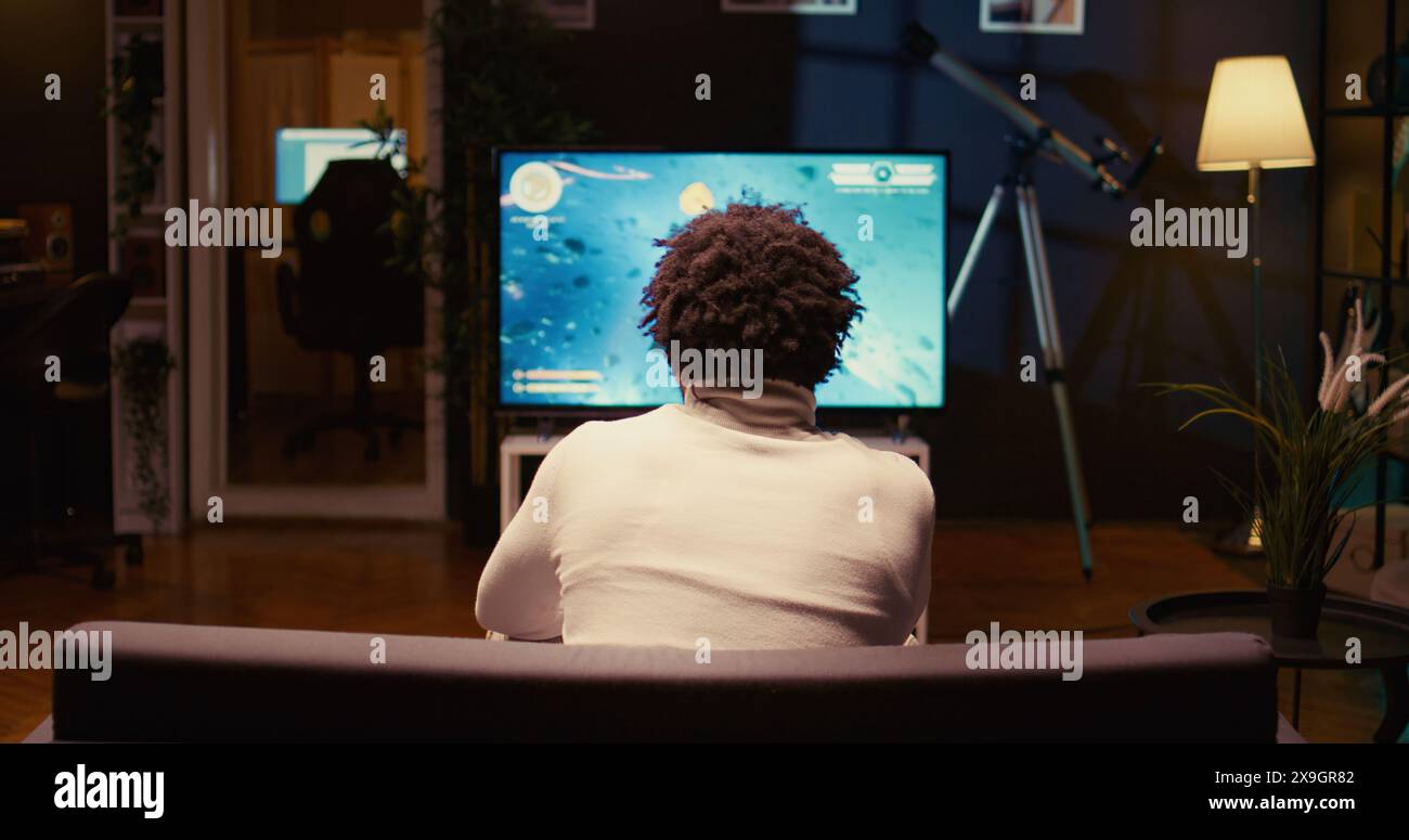 Bipoc Gamer Playing Classic Arcade Space Shooter Videogame On Modern Smart Tv Shooting