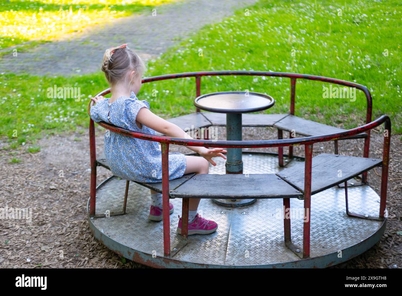 happy preschool girl, child spinning on carousel on summer day ...