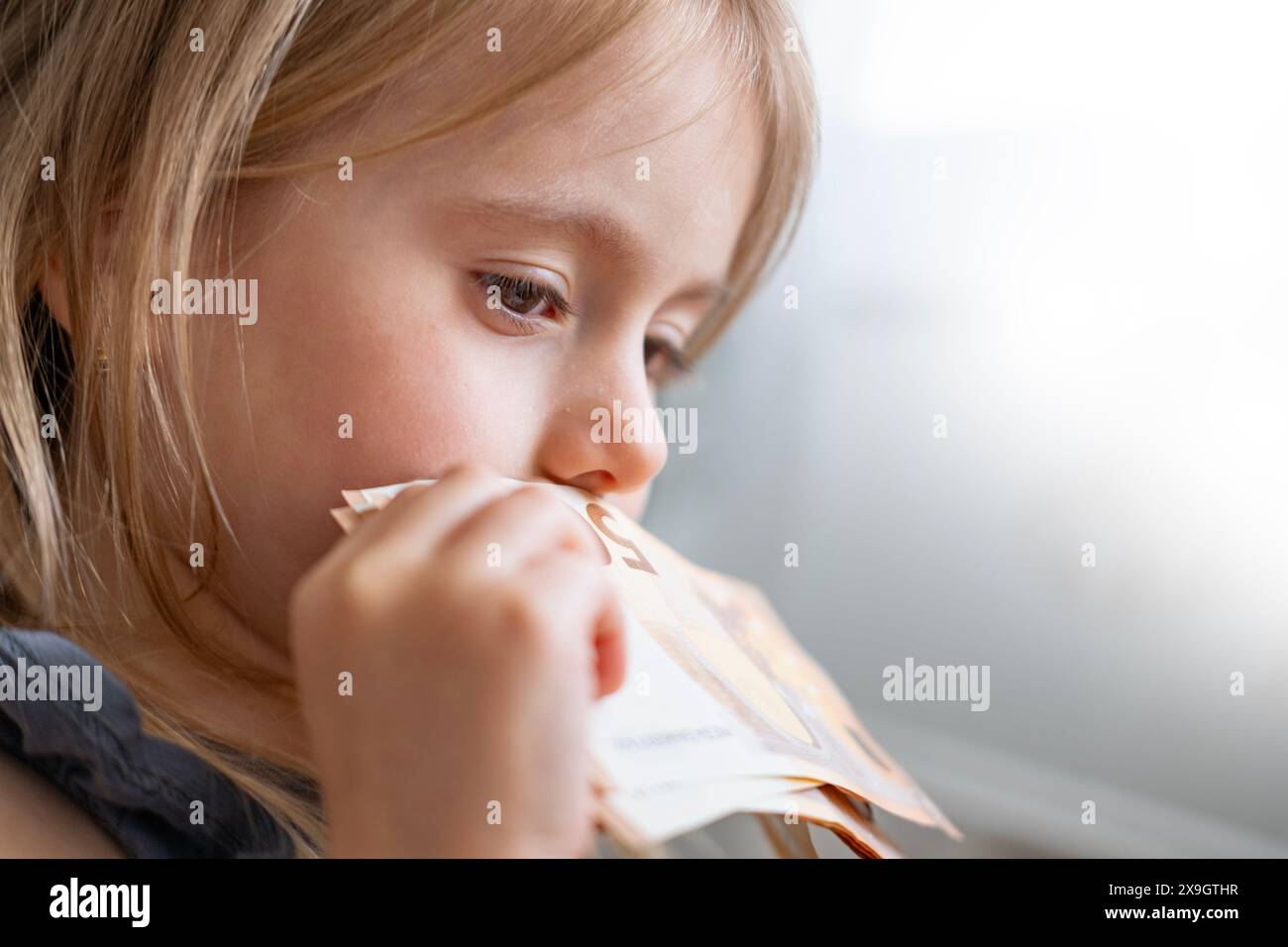 female child, girl holds 50 euro banknotes close-up, dreams and ...