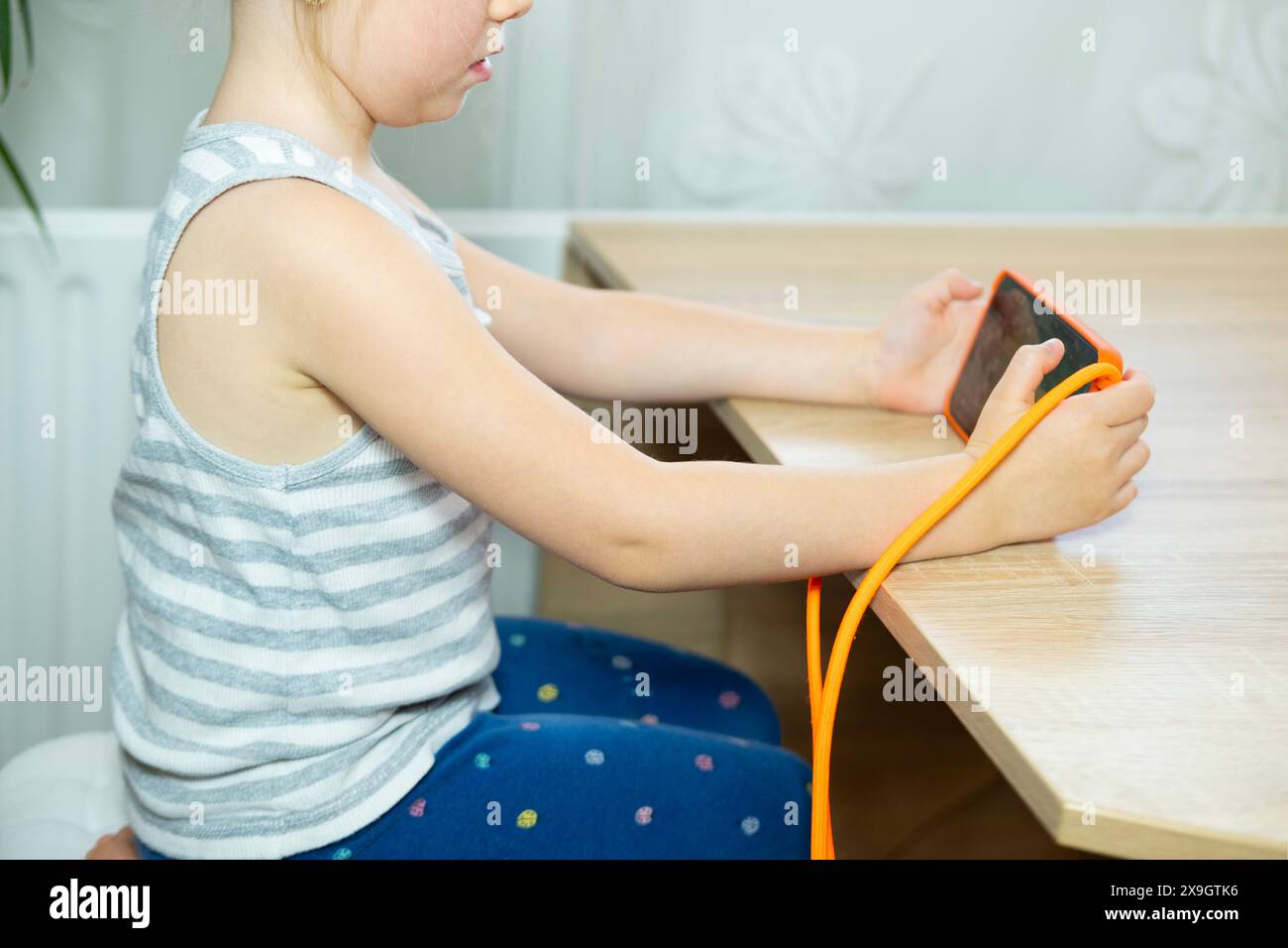 young girl maintains good posture while using phone, sitting with ...