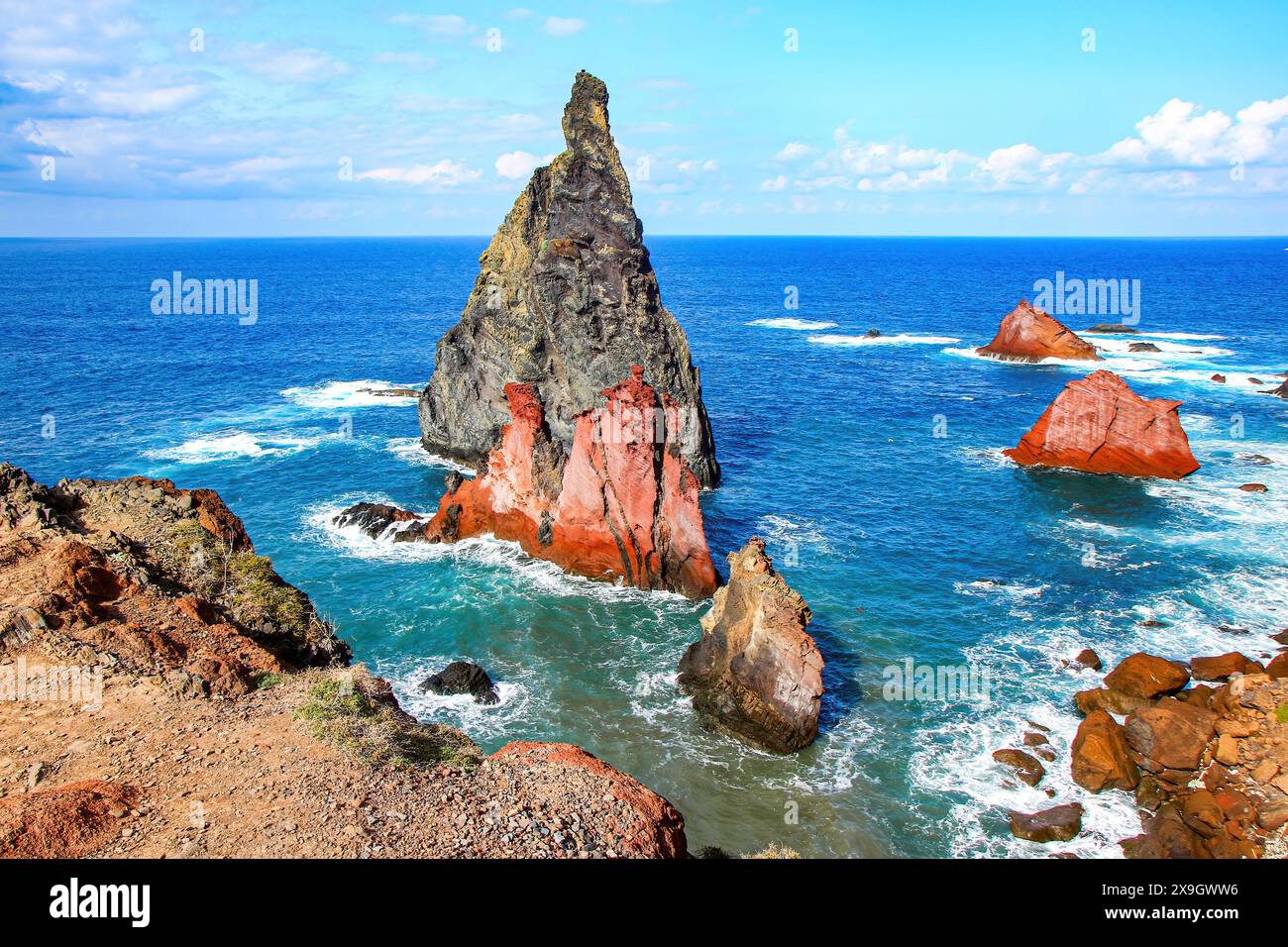 Red rock pillar protruding out of the Atlantic Ocean at the Ponta de ...