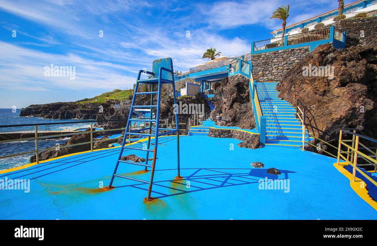 Outdoors swimming pool on a multi-level terrace among the coastal lava ...
