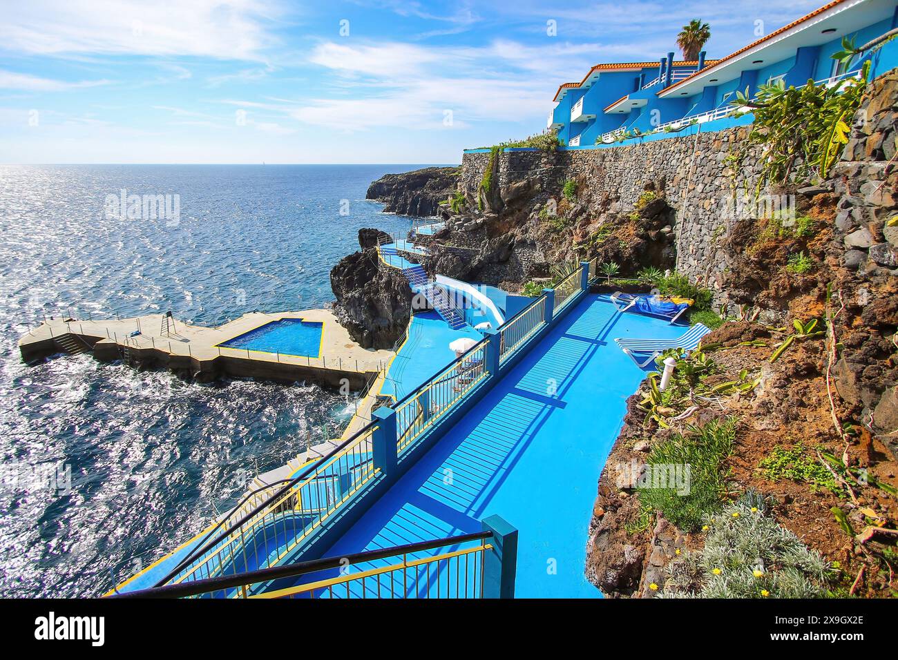 Outdoors swimming pool on a multi-level terrace among the coastal lava ...
