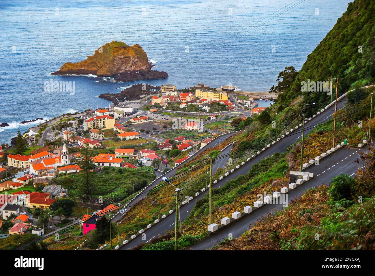 Aerial view of Porto Moniz and the winding road leading downhill ...