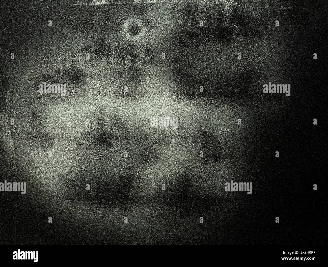 An abstract, grainy, and dark image with an eerie, face-like pattern ...