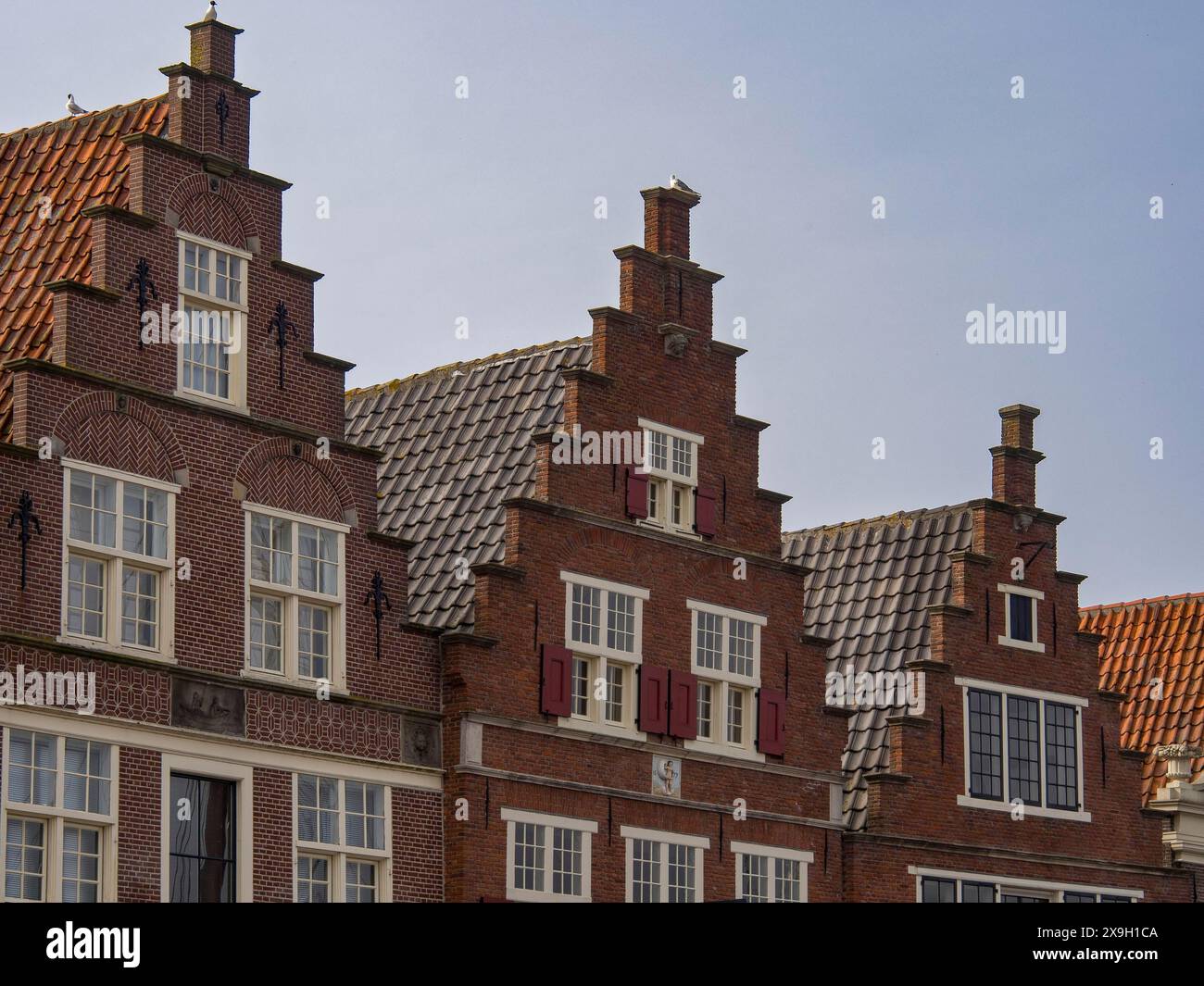 Historic gabled brick houses arranged in rows, with pointed roofs and ...
