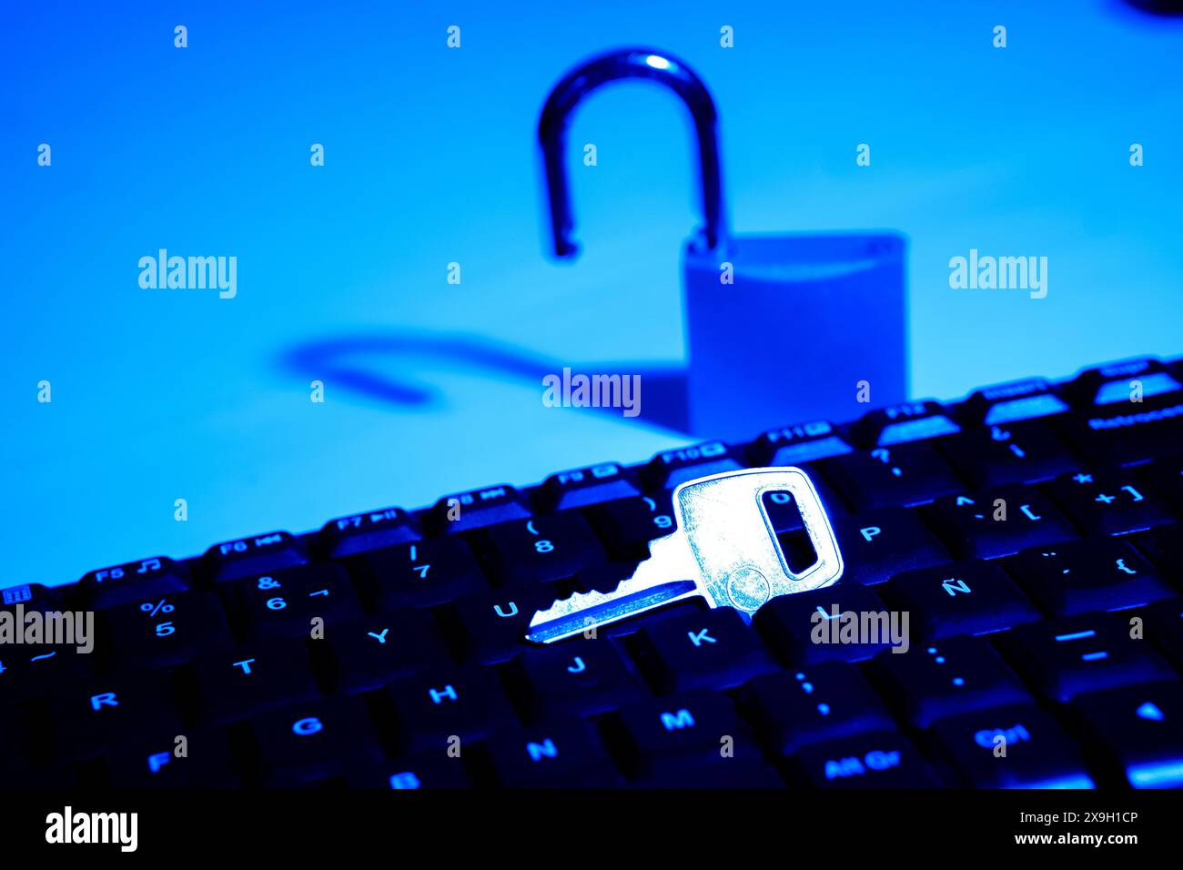 A lock and key on top of the keyboard Stock Photo - Alamy