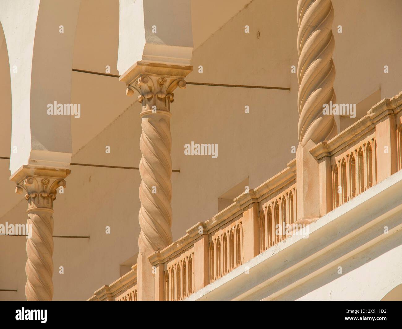 Beige columns and arches of a building with architectural details ...
