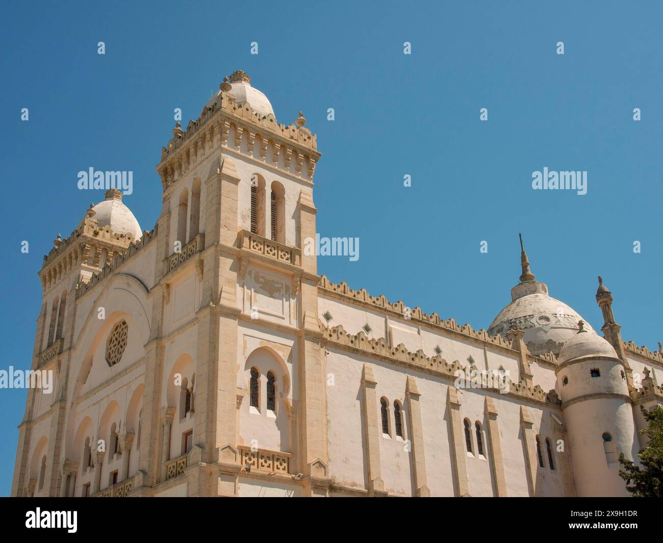 Large historic building with domes and decorations under a clear blue ...
