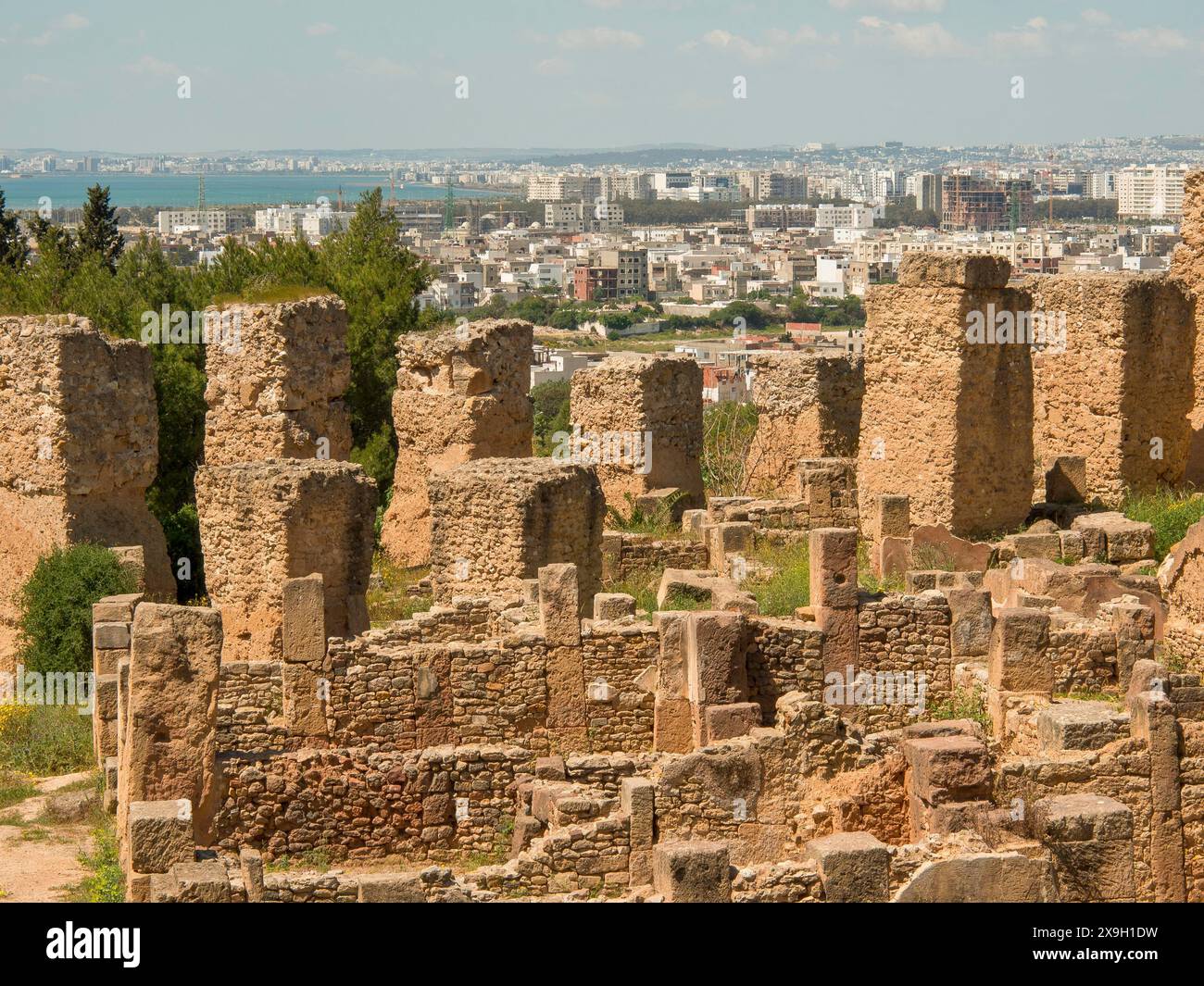 Historic stone ruins with a view of the modern city in the background ...