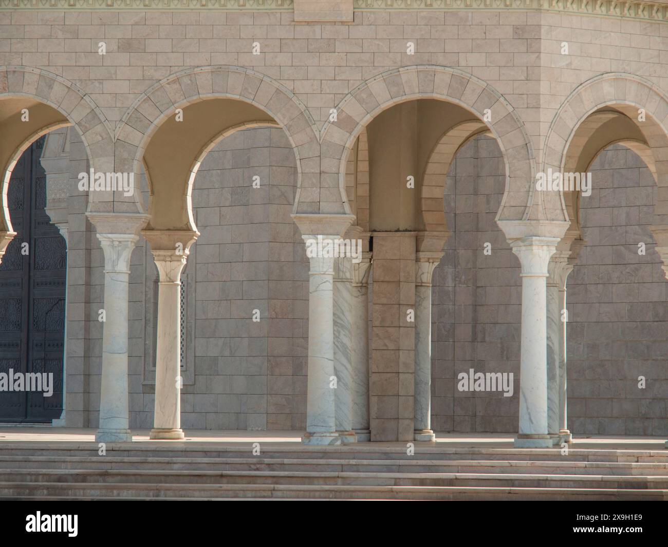 Stone columns and open arcades of an ancient building with stone steps ...