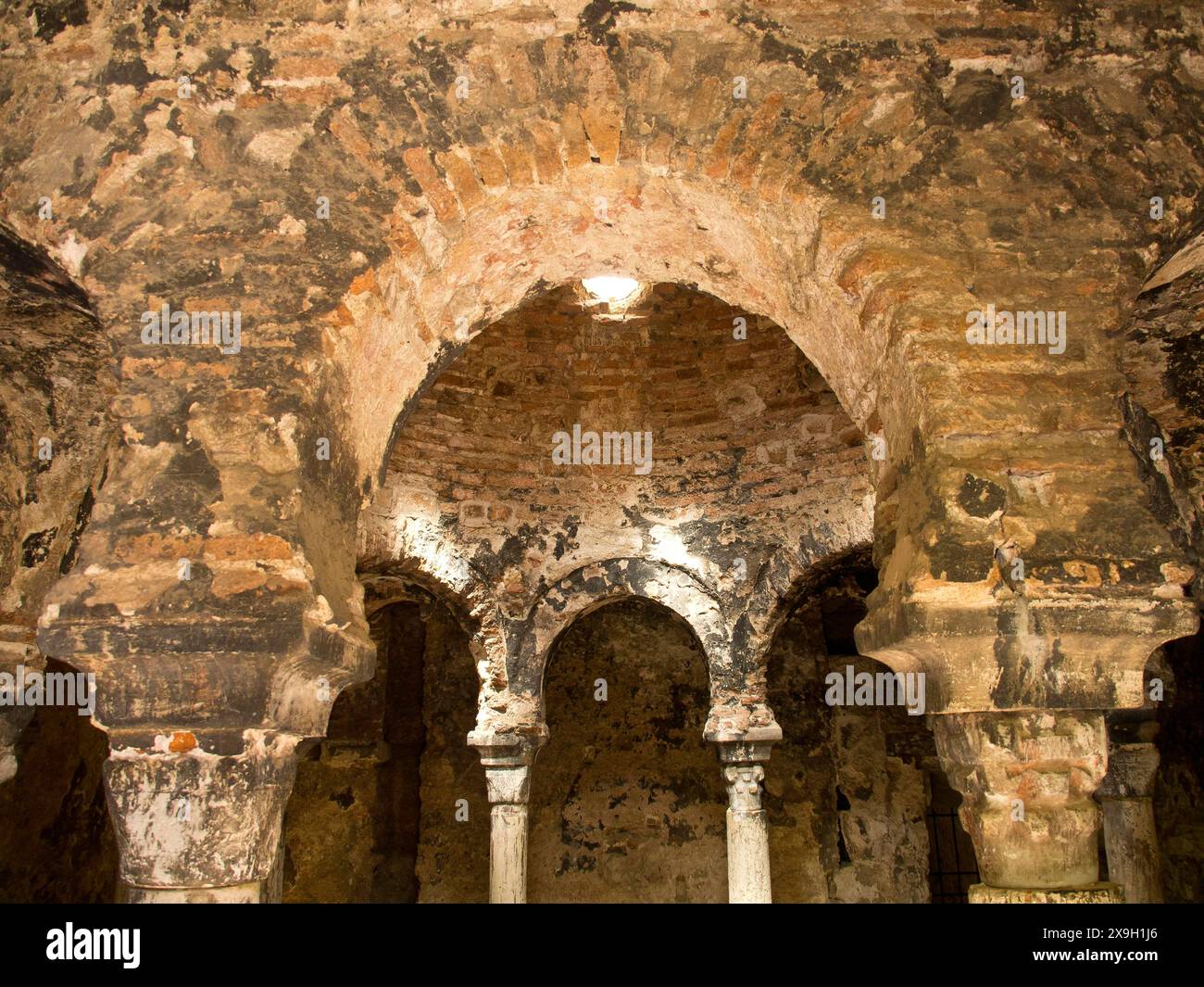 Interior with vaulted ceilings, decorative stone columns and historical ...