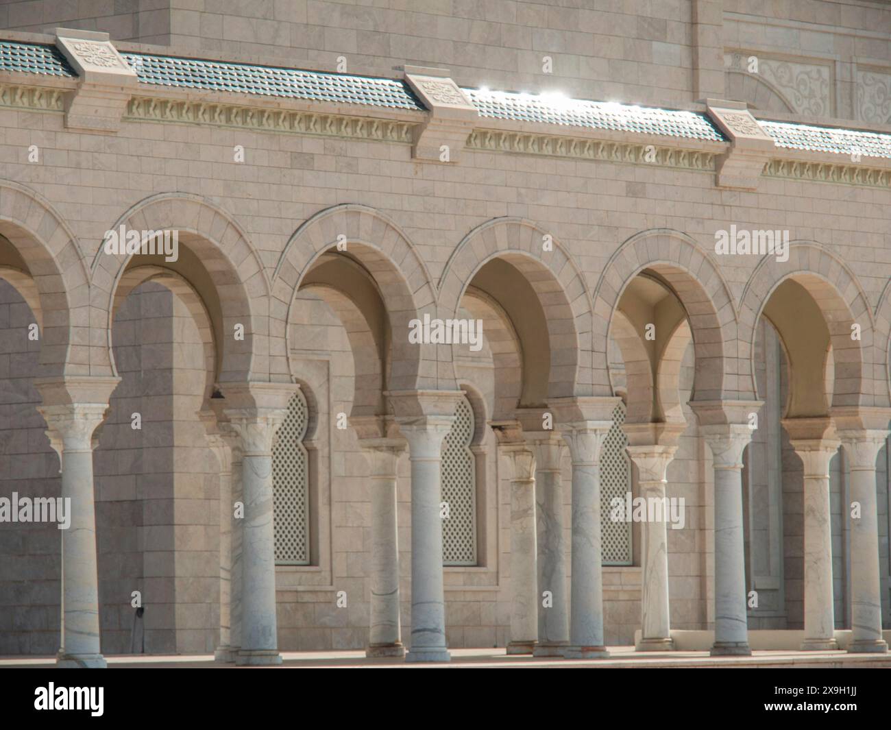A sun-drenched building with marble columns and arcades that hints at ...