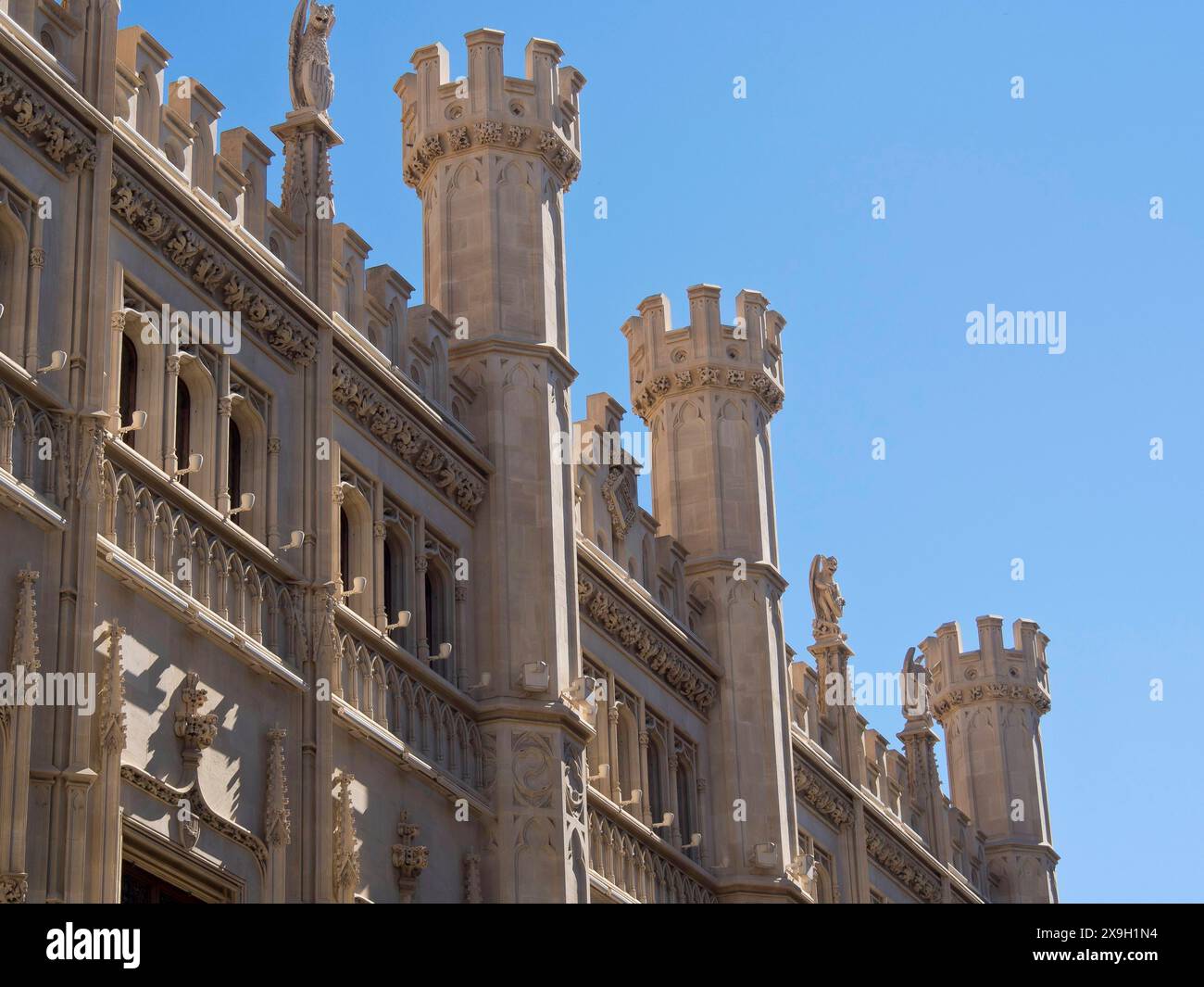 Historic building with stone, ornate towers and a clear blue sky in the ...